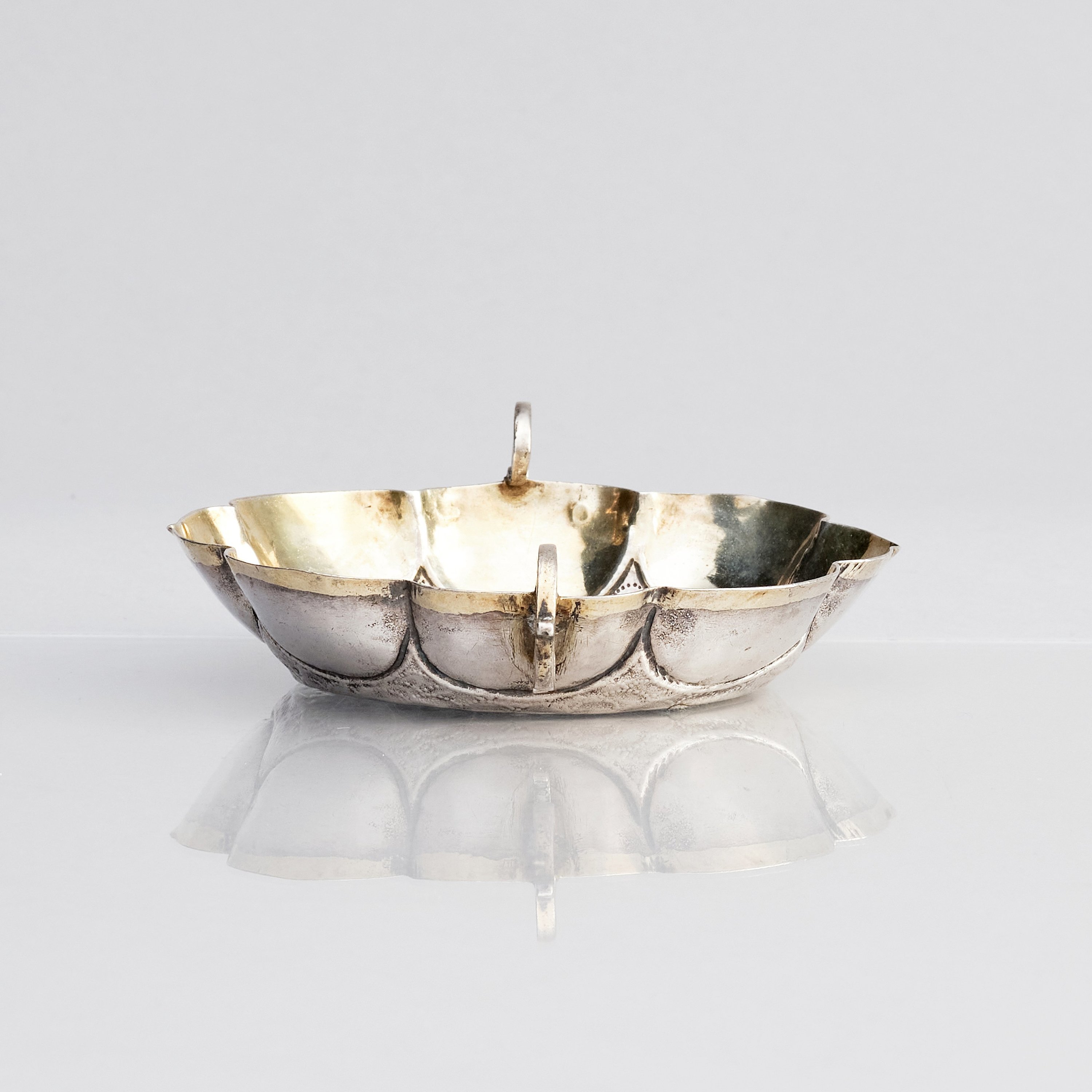 A small German parcel-gilt silver dish (possibly wine tasting bowl ...