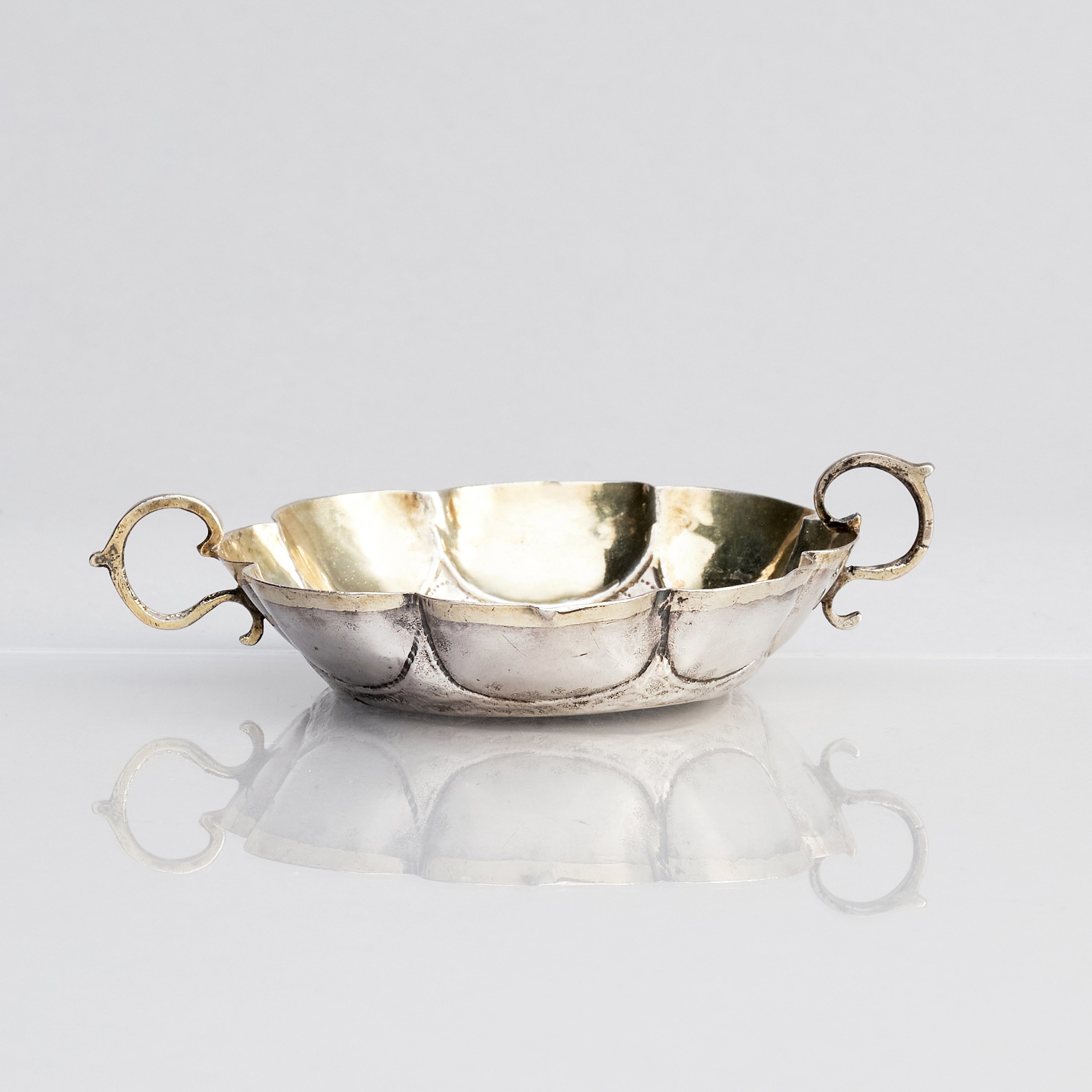 A small German parcel-gilt silver dish (possibly wine tasting bowl ...