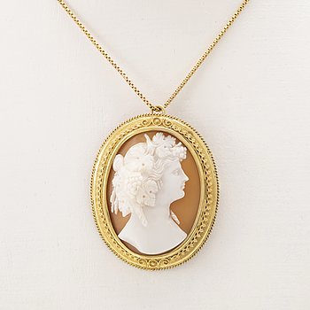 A Pendant/Brooch of carved shell cameo set in 14K gold and chain of low ...