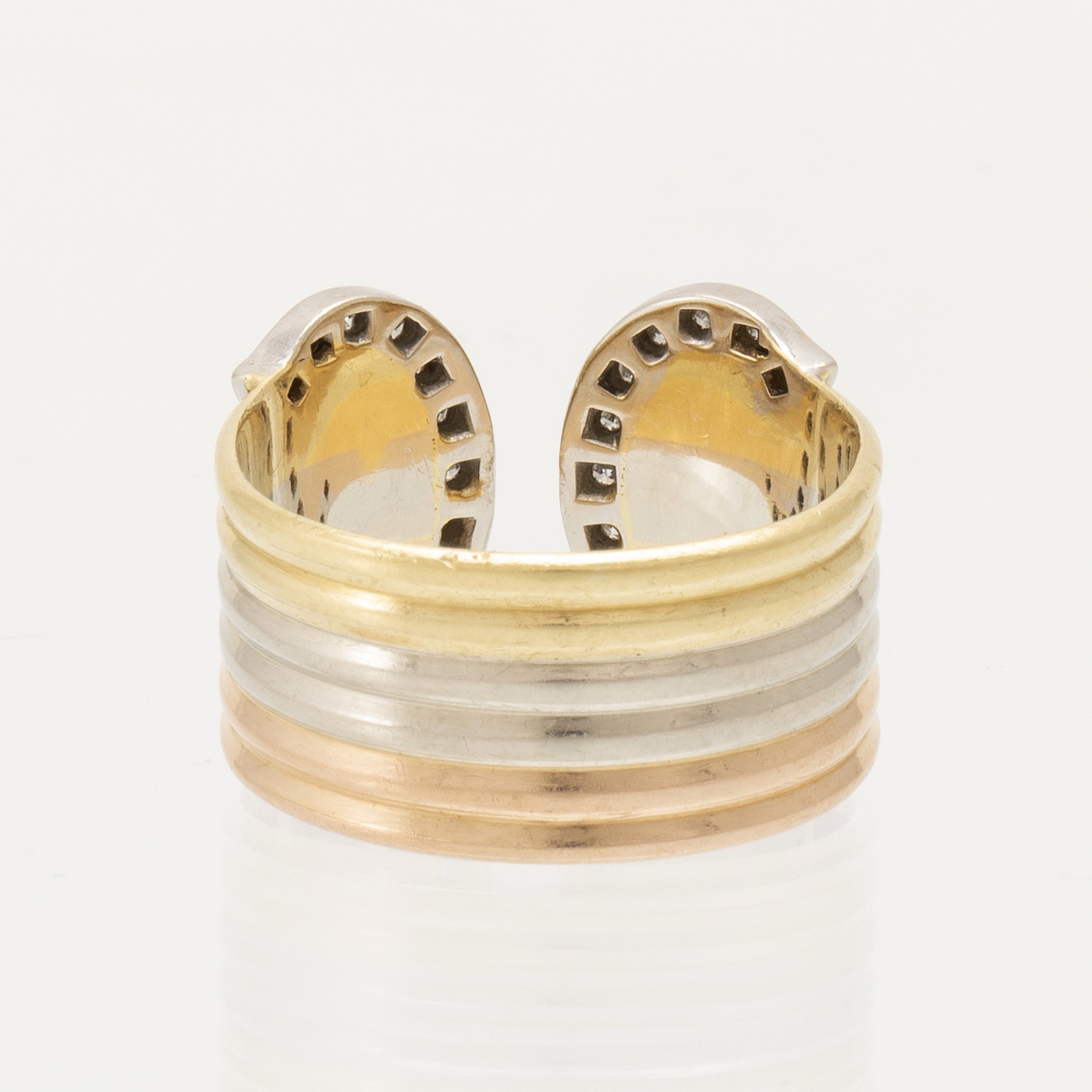 A Cartier "Double C" ring 18K tricolor gold set with round single-cut ...