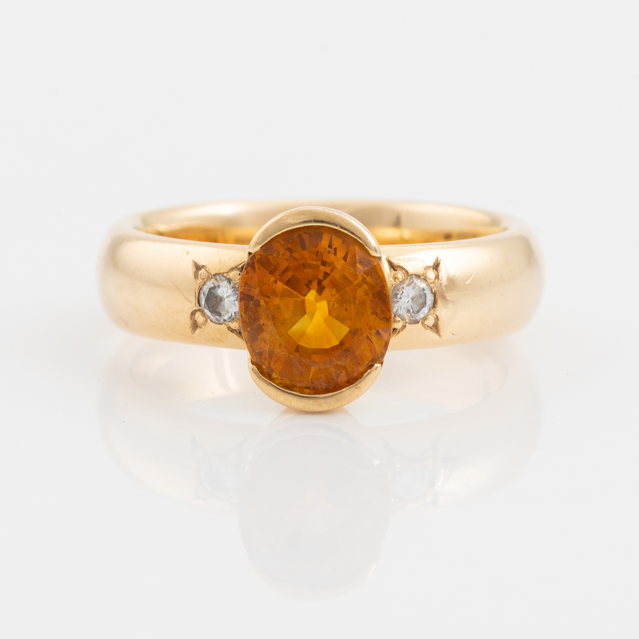 Ring guld med orange safir samt briljantslipade diamanter. - Bukowskis
