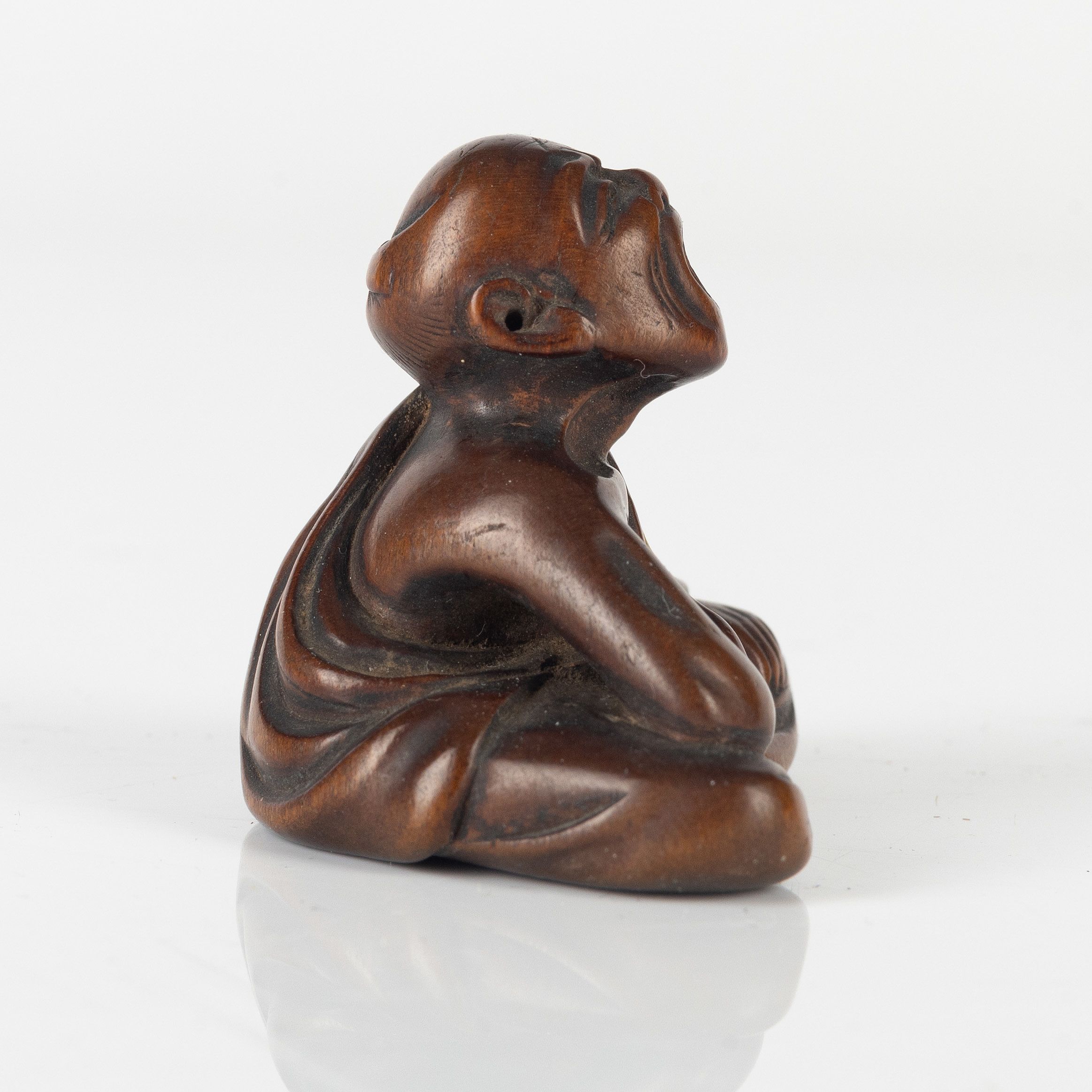 A wood netsuke of a professional sneezer, signed Gyokkō, 19th century ...
