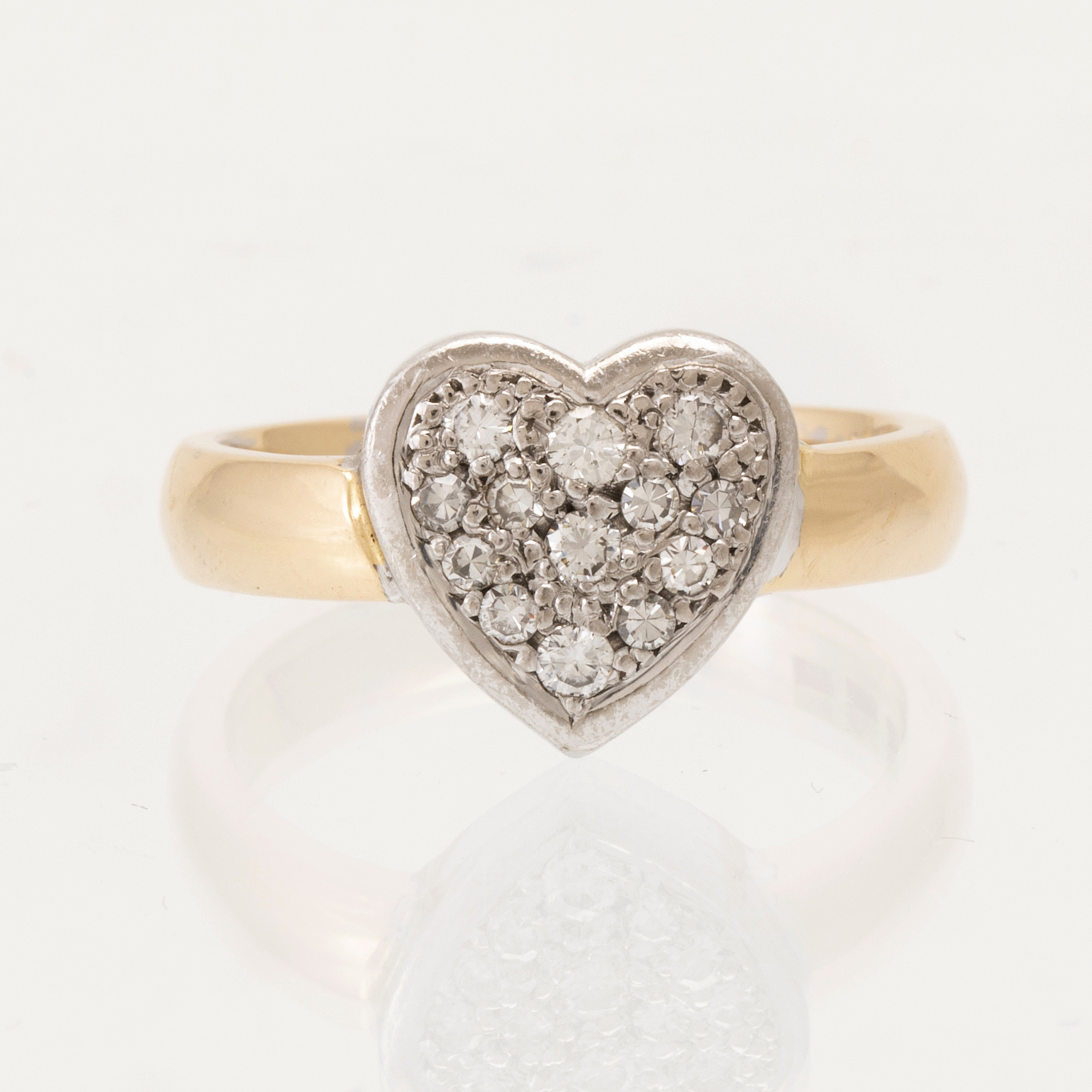 An 18K white and red gold ring set with round brilliant-cut and single ...