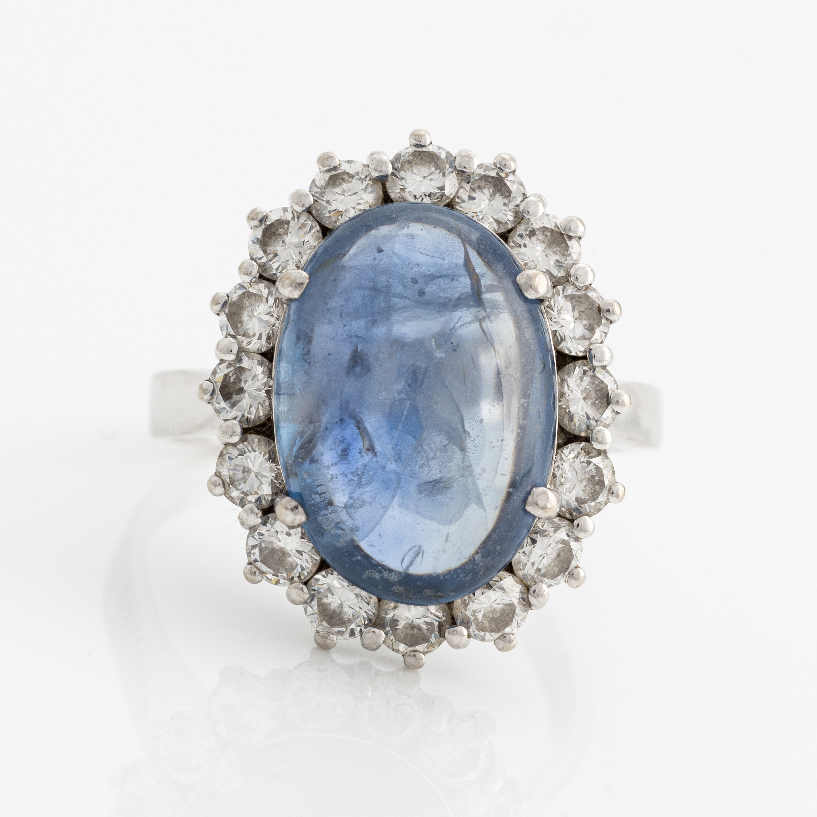 Ring with cabochon-cut sapphire and brilliant-cut diamonds. - Bukowskis