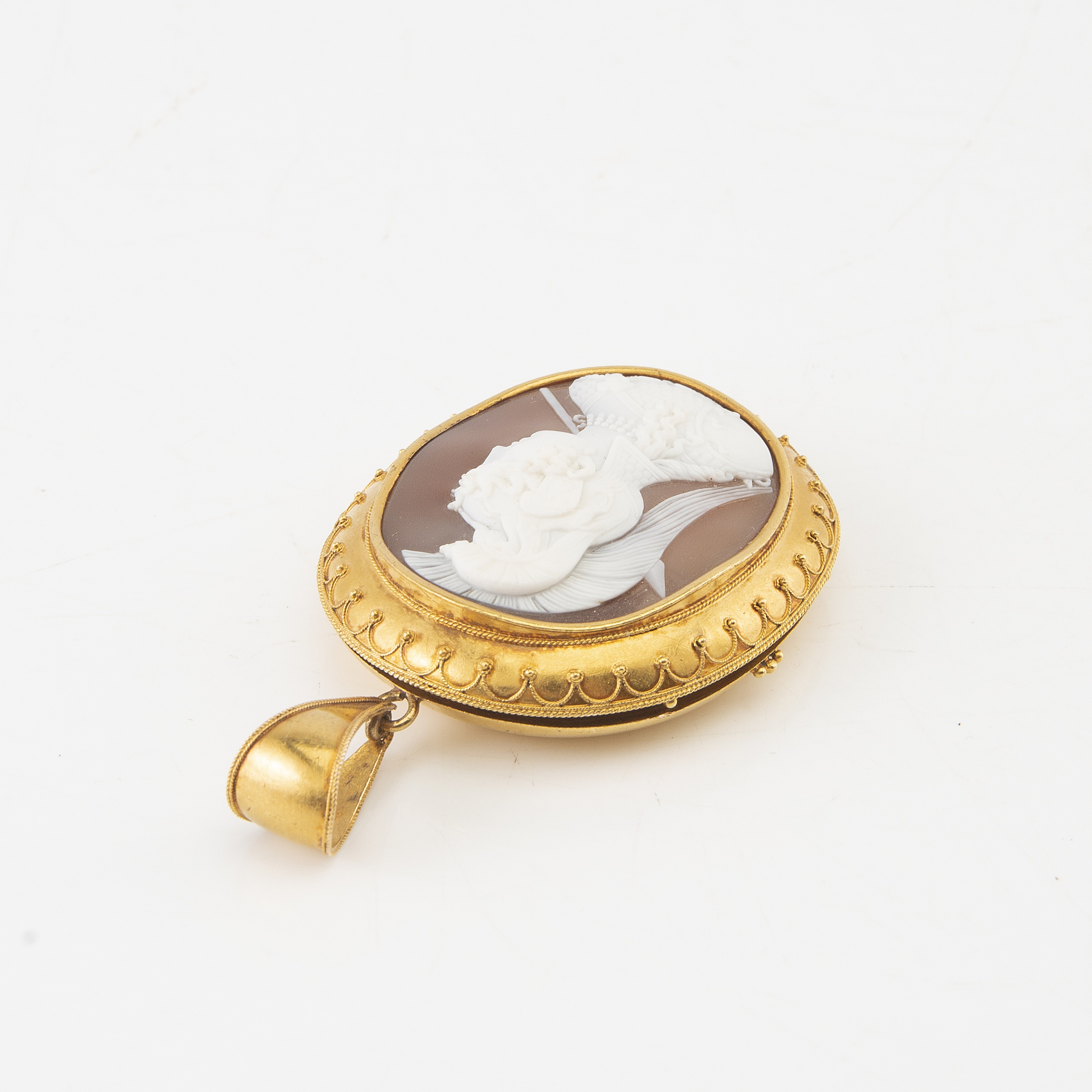 A 14K gold medallion with carved shell cameo. - Bukowskis