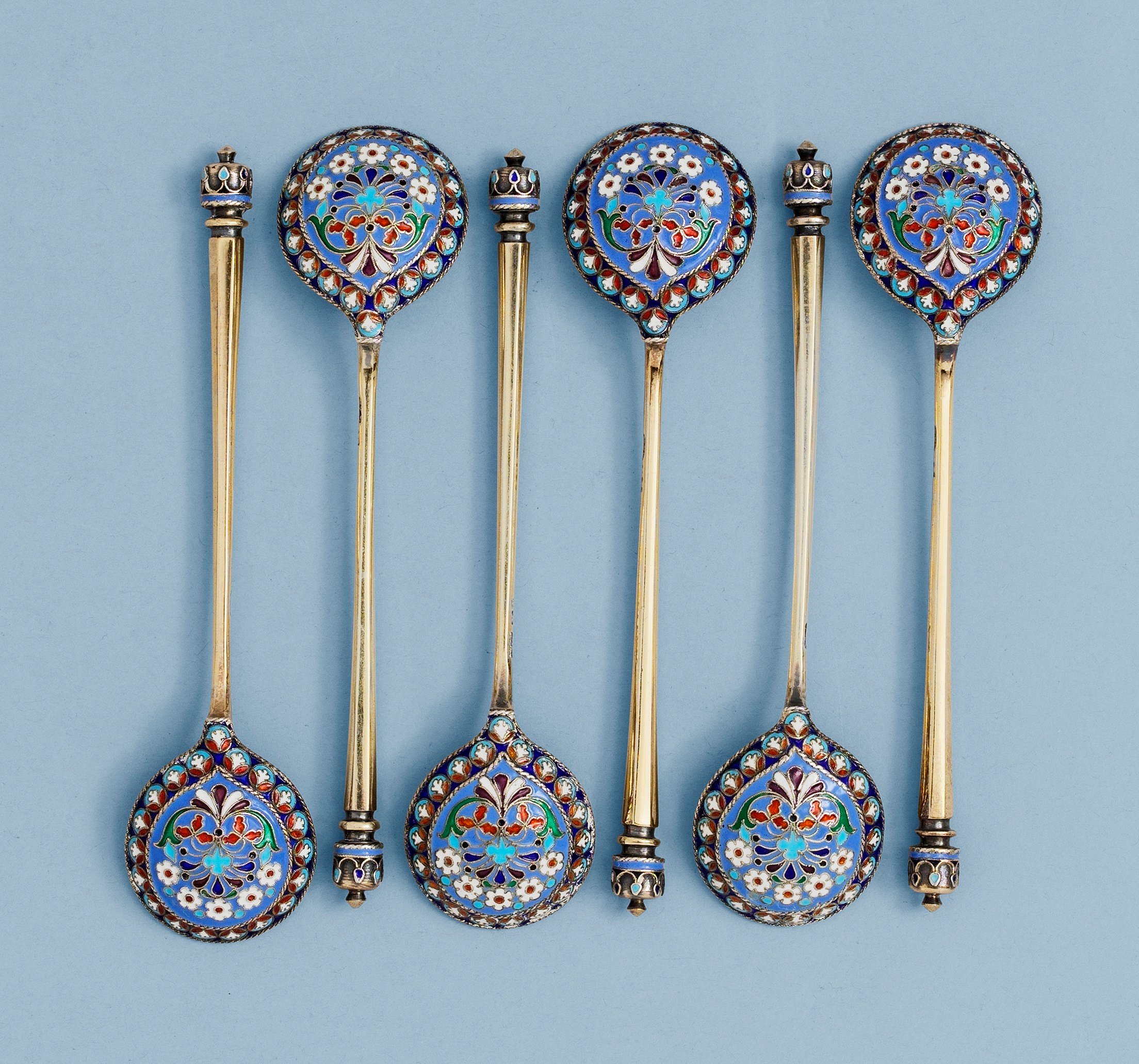 A SET OF SIX RUSSIAN SILVER AND ENAMEL TEA-SPOONS, makers mark of Ivan ...