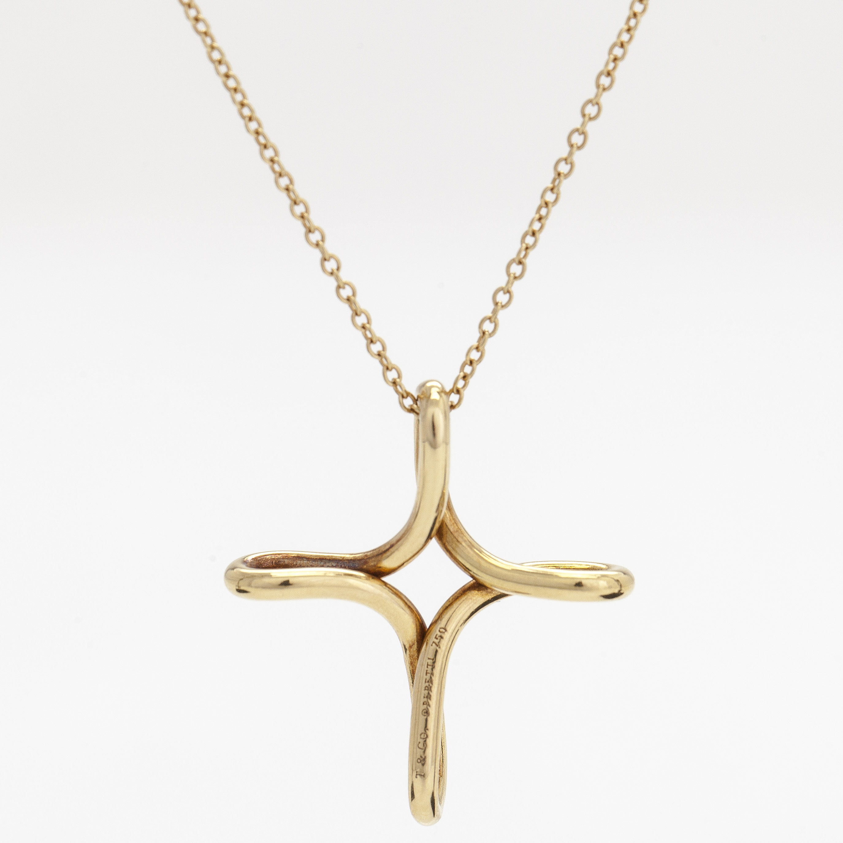Tiffany & Co, Elsa Peretti, an 18K gold 'Infinity Cross' necklace ...