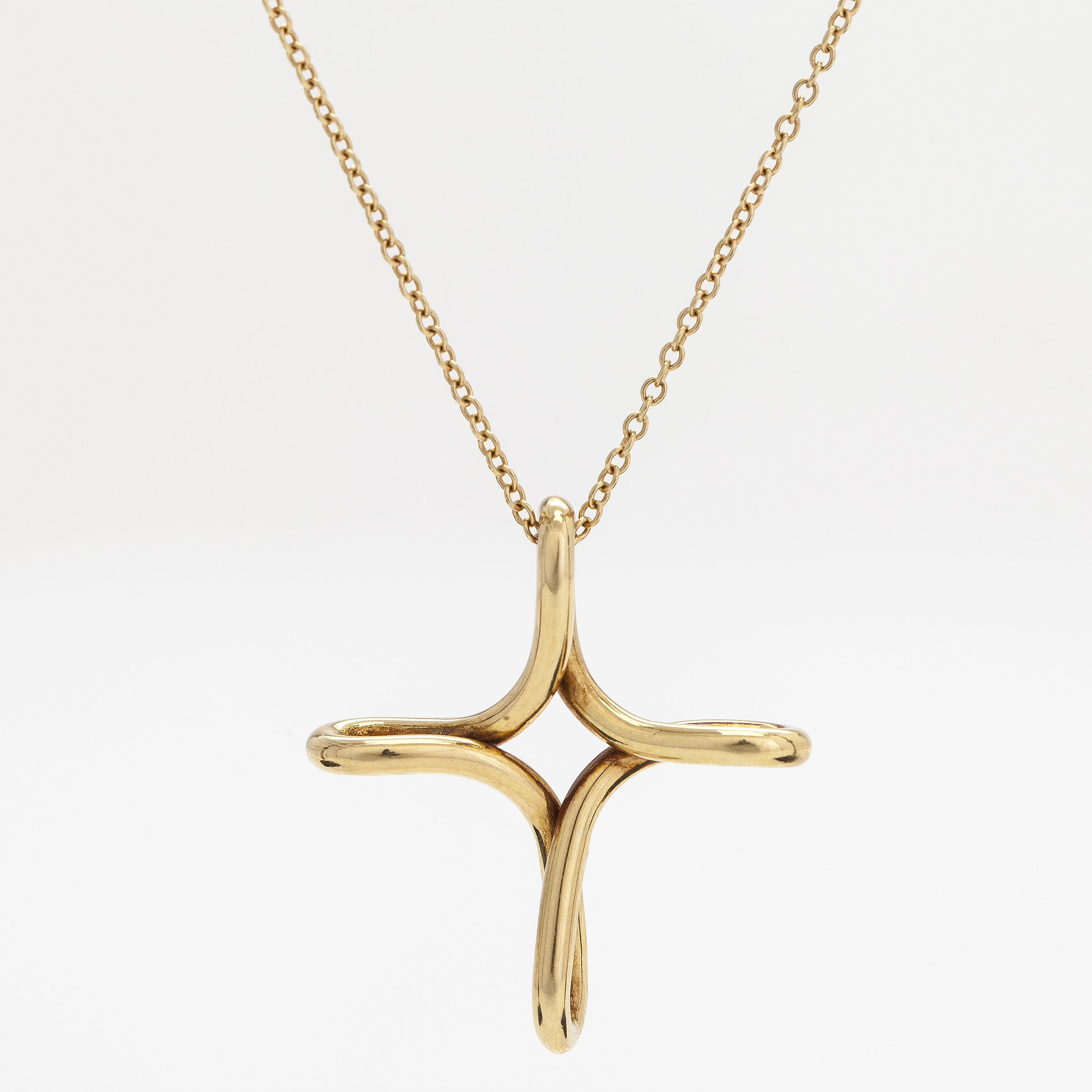 Tiffany & Co, Elsa Peretti, an 18K gold 'Infinity Cross' necklace ...