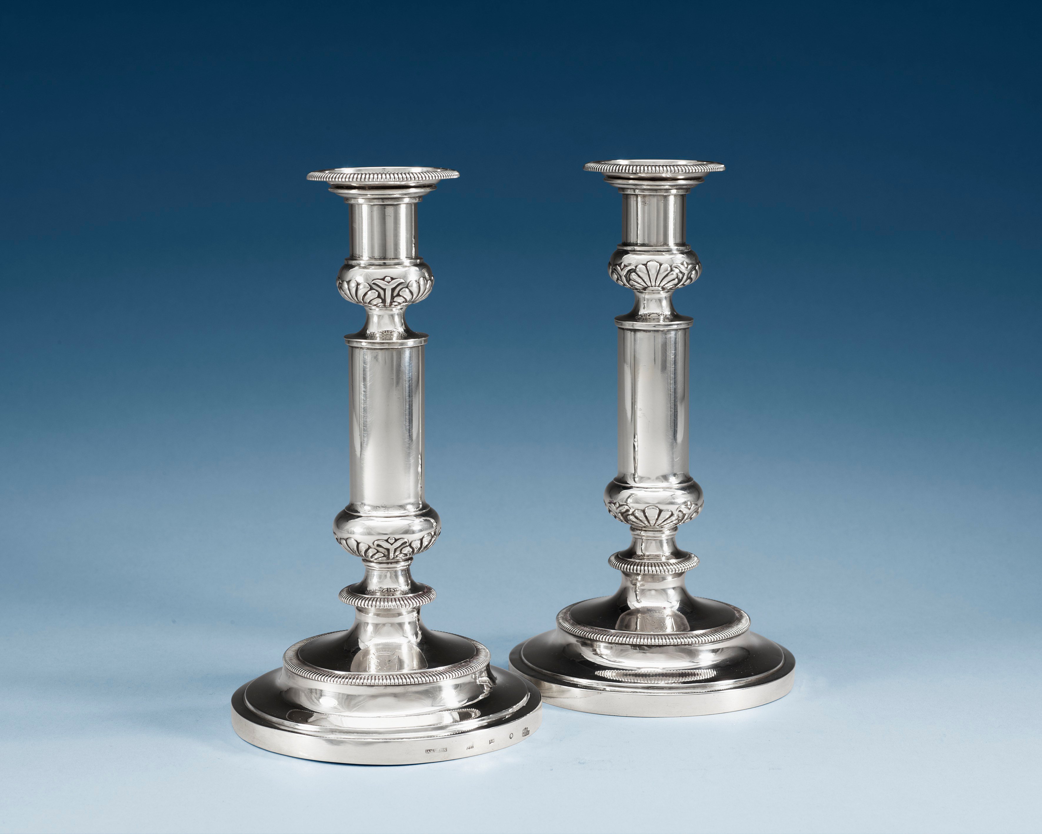 A PAIR OF RUSSIAN SILVER CANDLESTICKS, Makers mark of Nichols & Plinke ...