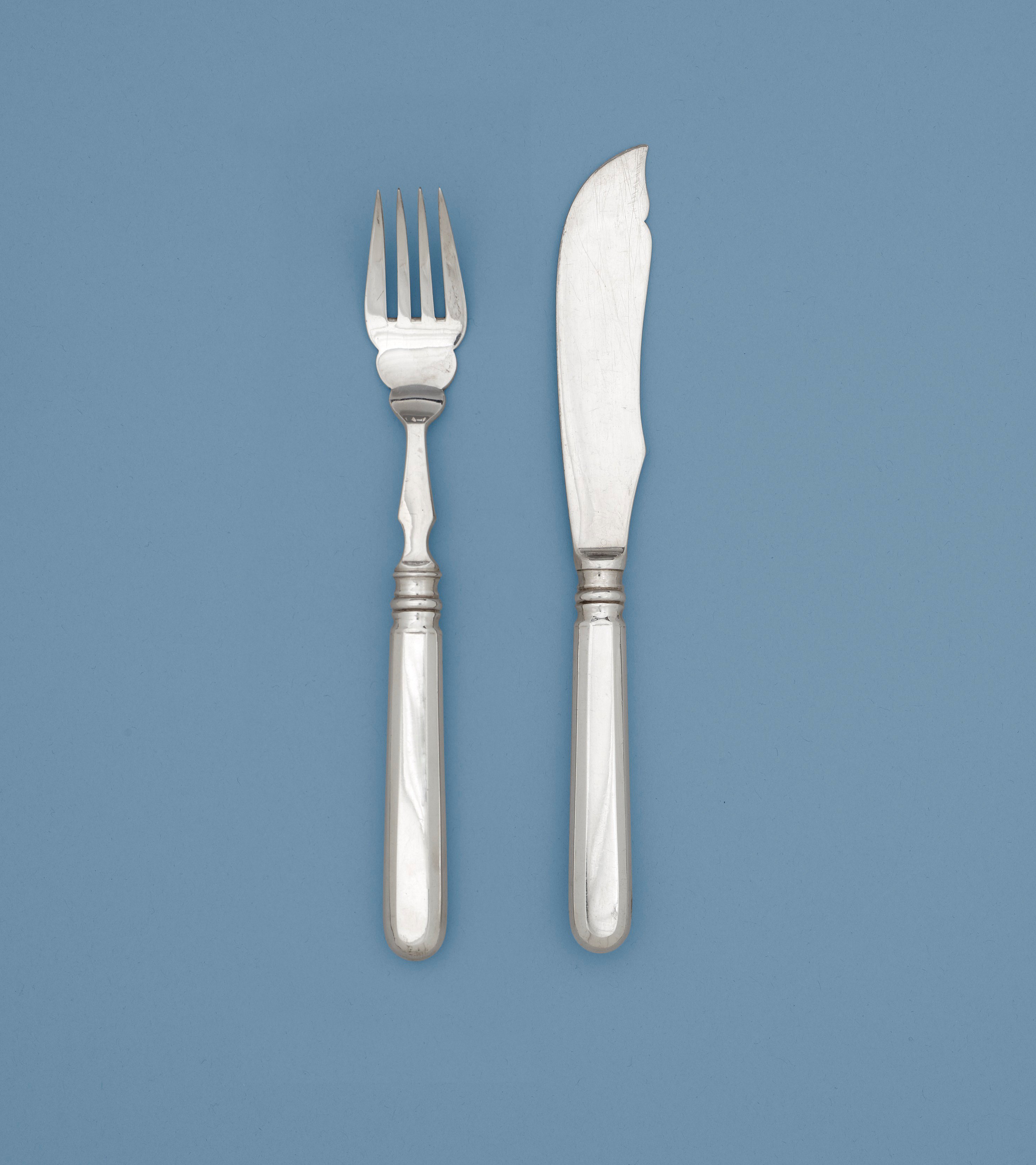 A Russian set of 24 silver fish forks and knivs, makers mark of Mikhail ...