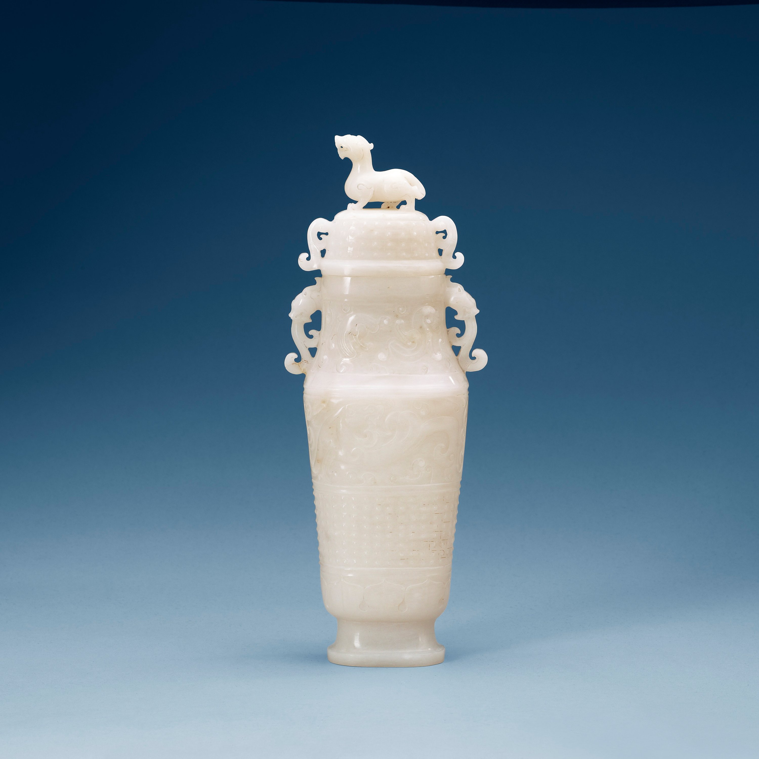 A archaistic carved white stone vase with cover. - Bukowskis