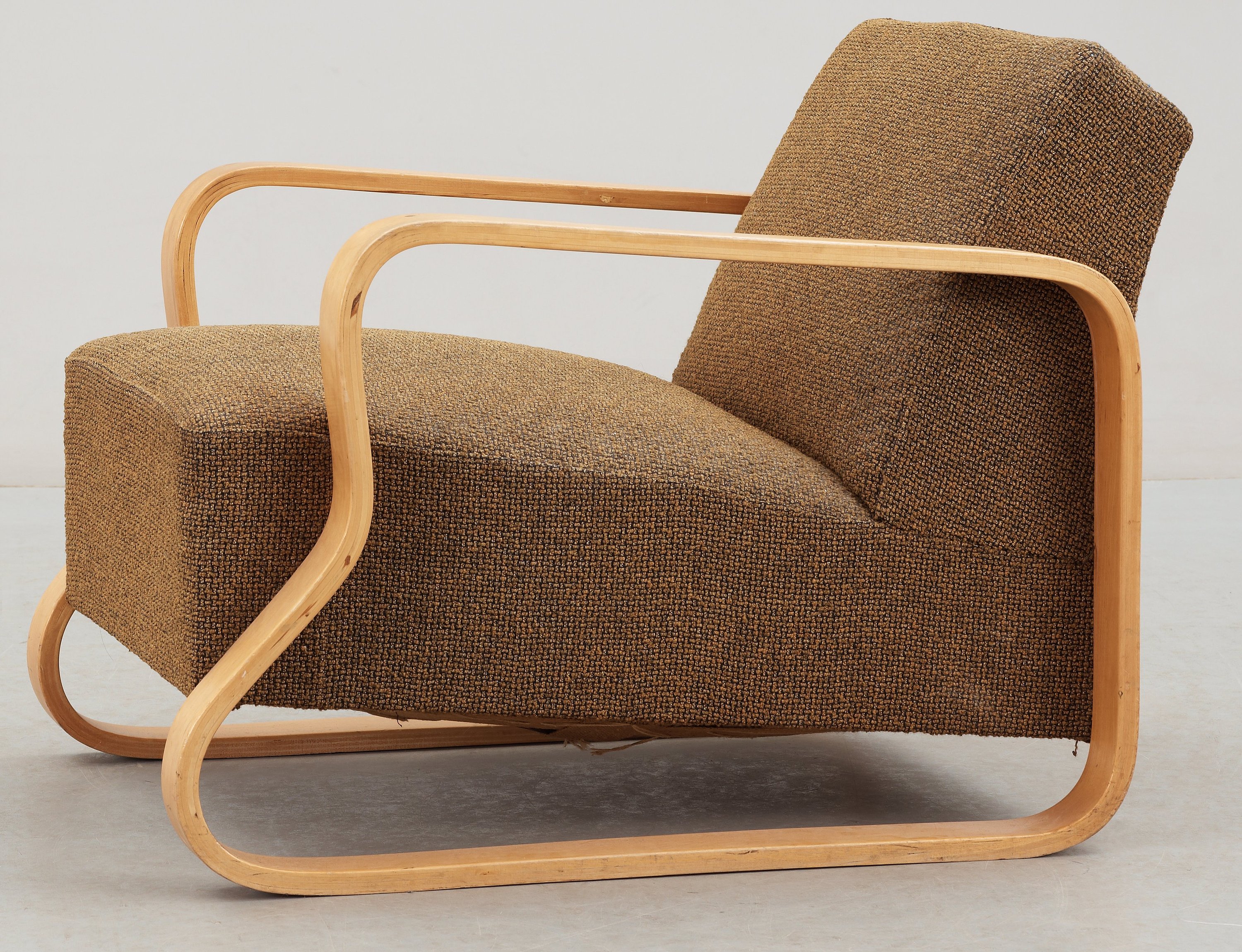 An Alvar Aalto laminated birch 'padded Paimio chair', upholstered in ...