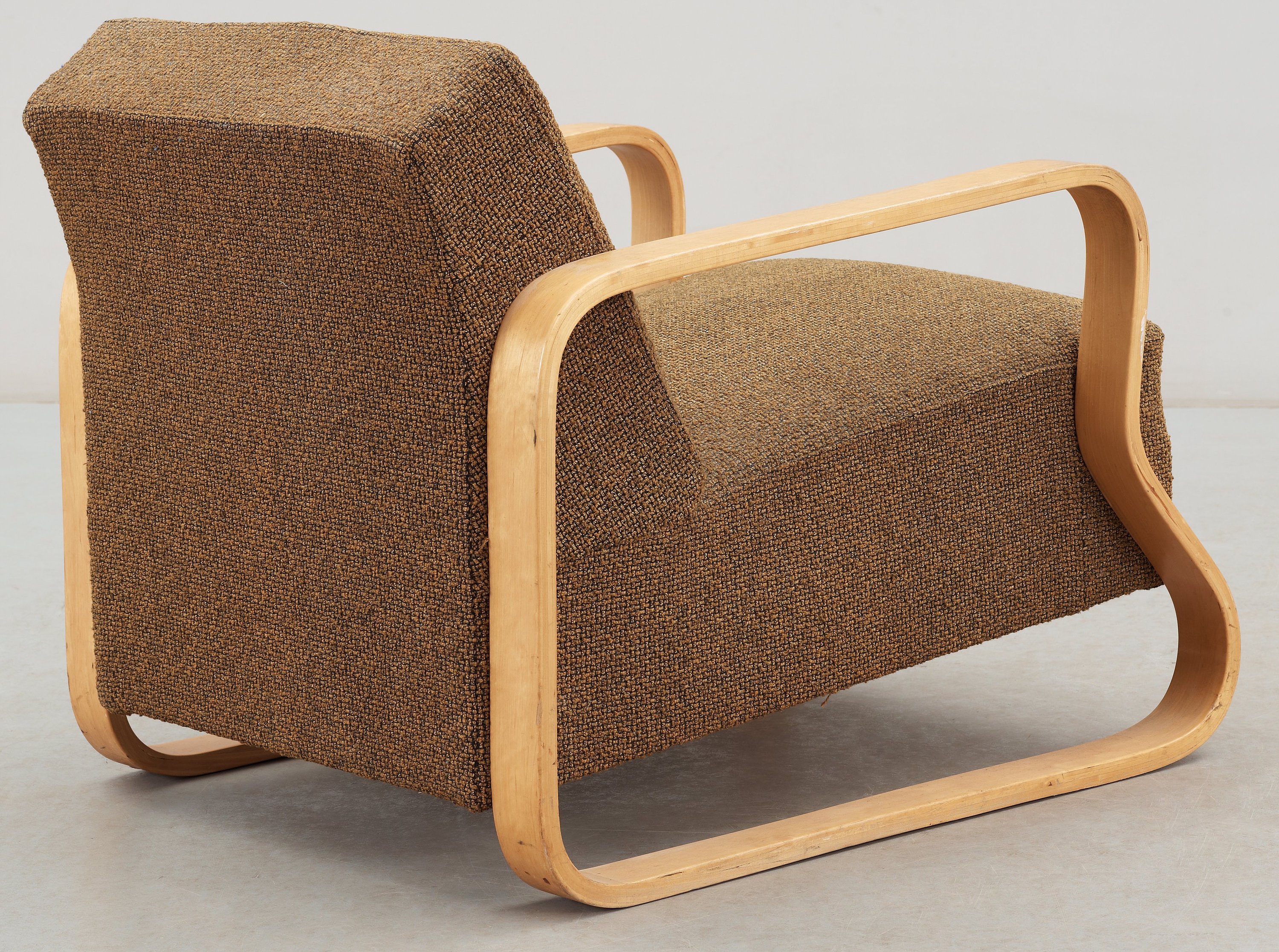 An Alvar Aalto laminated birch 'padded Paimio chair', upholstered in ...