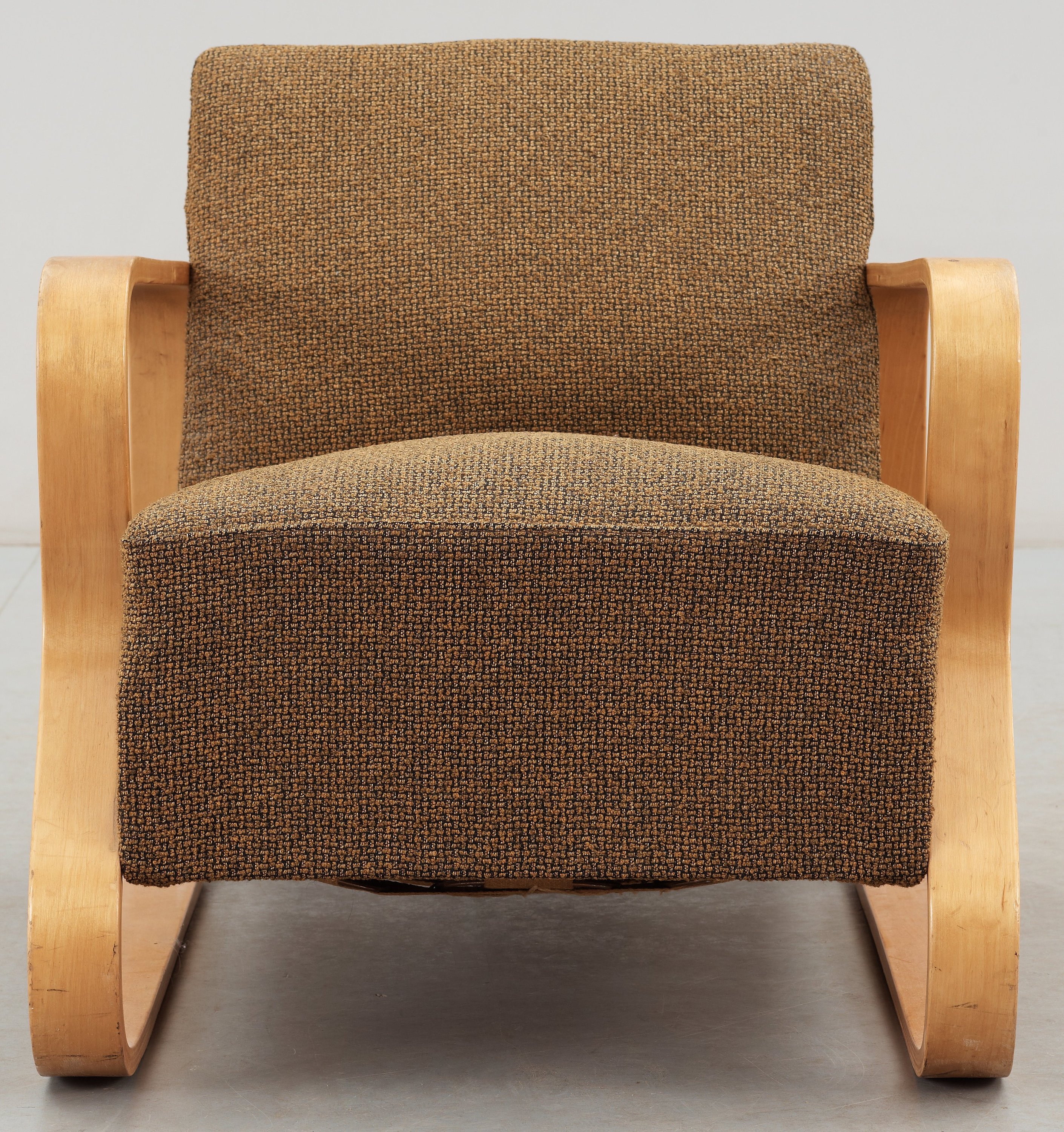 An Alvar Aalto laminated birch 'padded Paimio chair', upholstered in ...