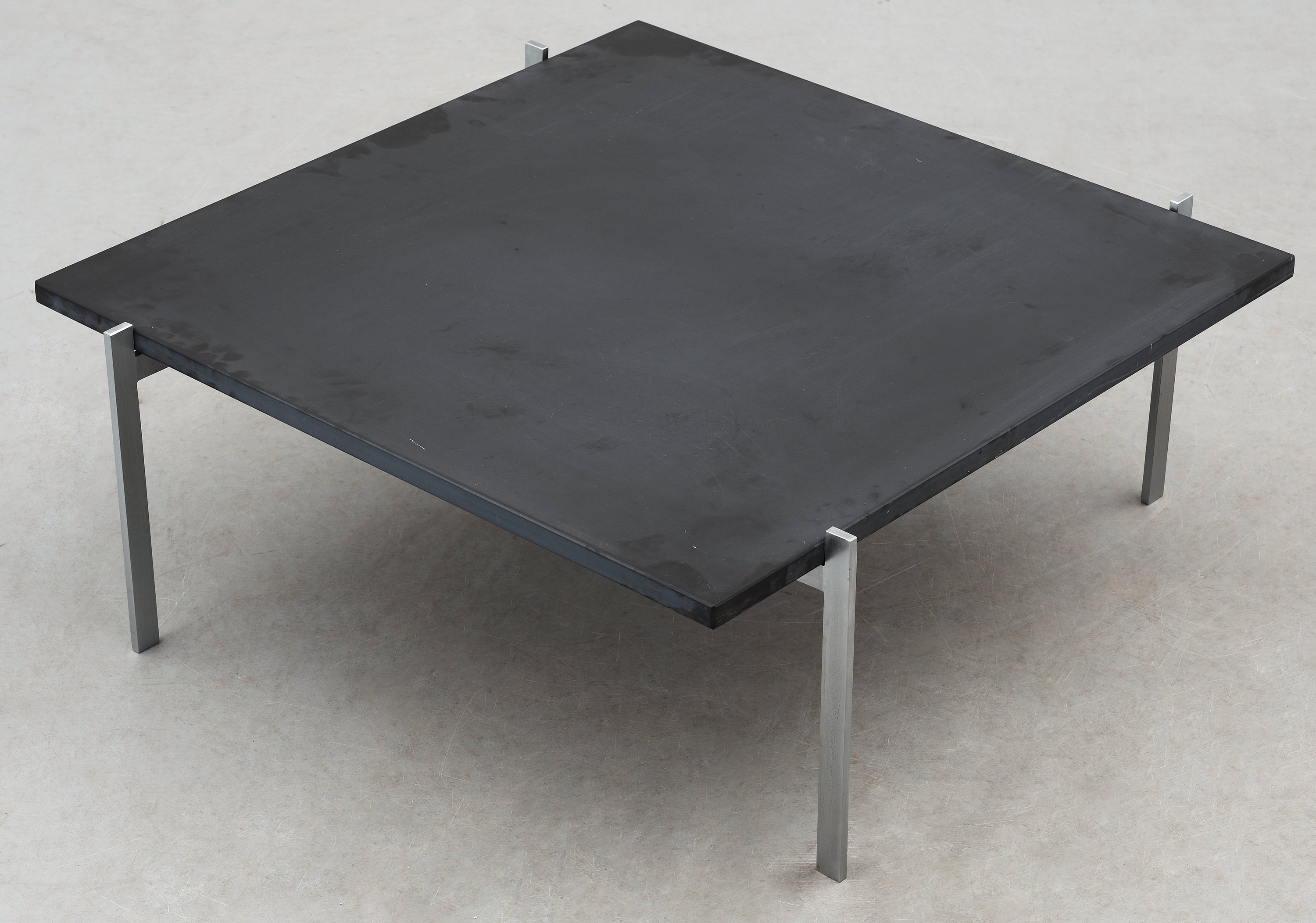 A Poul Kjaerholm 'PK-61' black slate and steel sofa table, Fritz Hansen ...