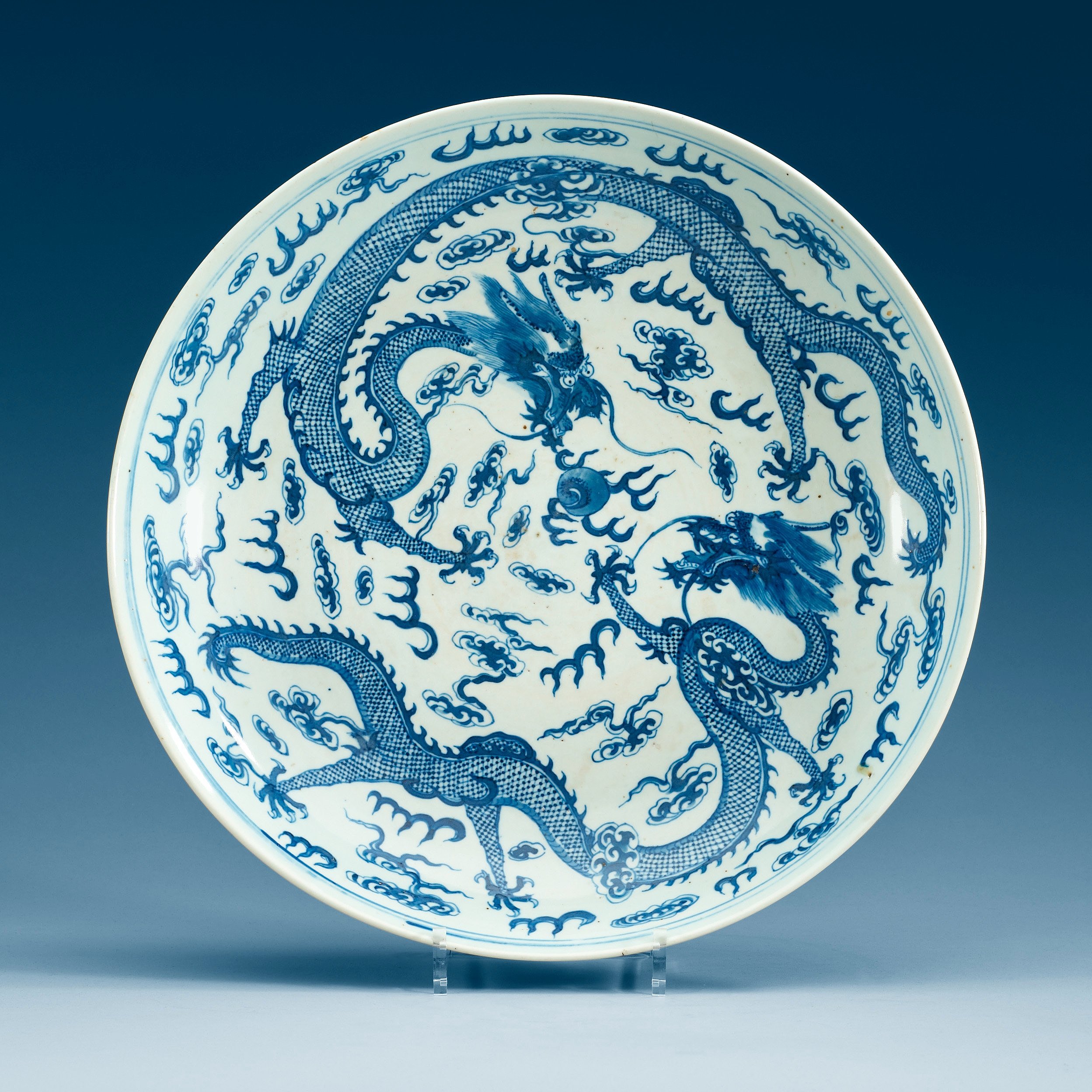 A large blue and white with five clawed dragon dish, Qing dynasty with ...