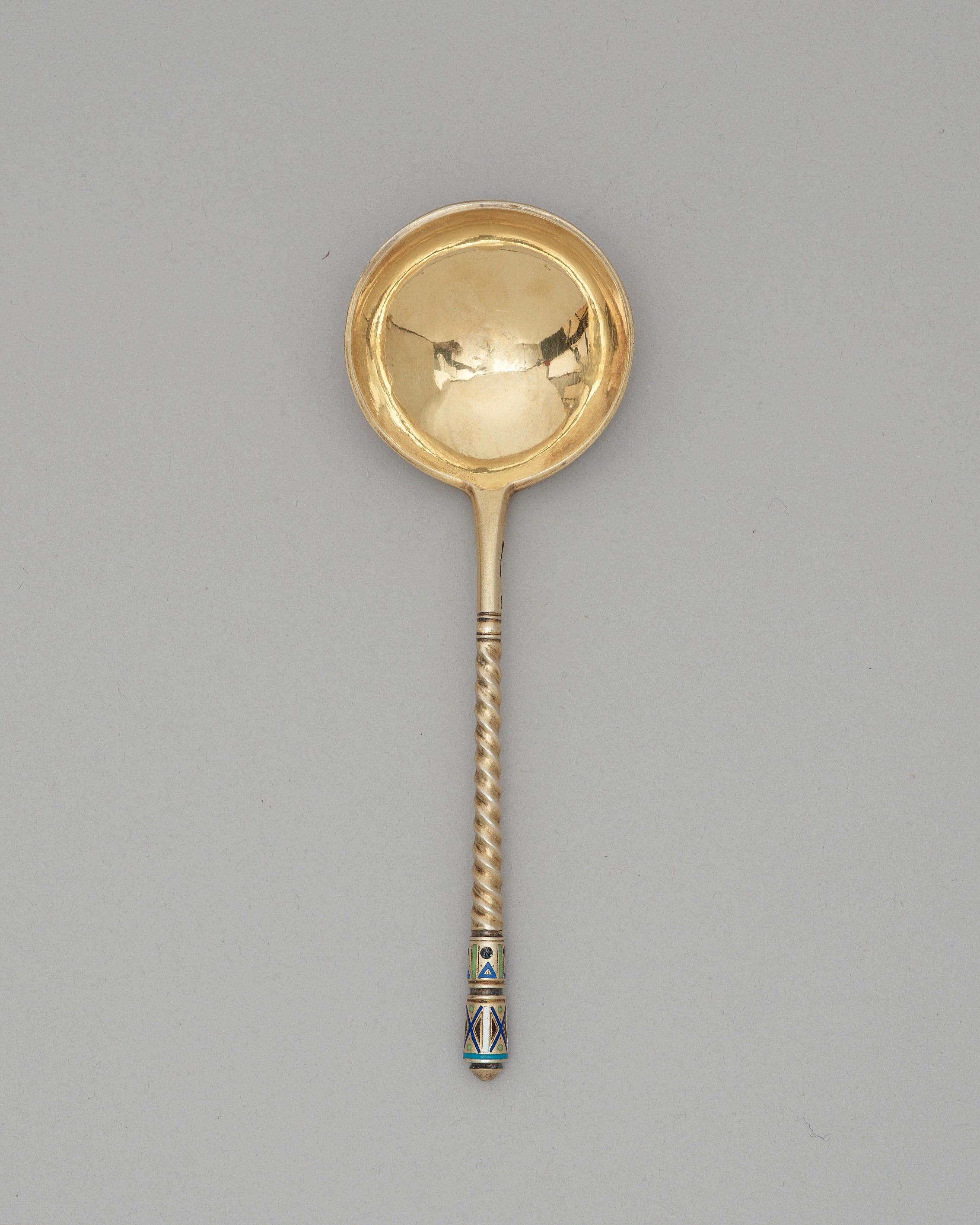 A Russian 19th century silver-gilt and enamel caviar-spoon, marks of ...