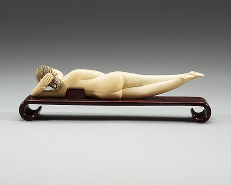 A ivory figure of a reclining 'Doctors Lady' on a wooden stand, Qing ...