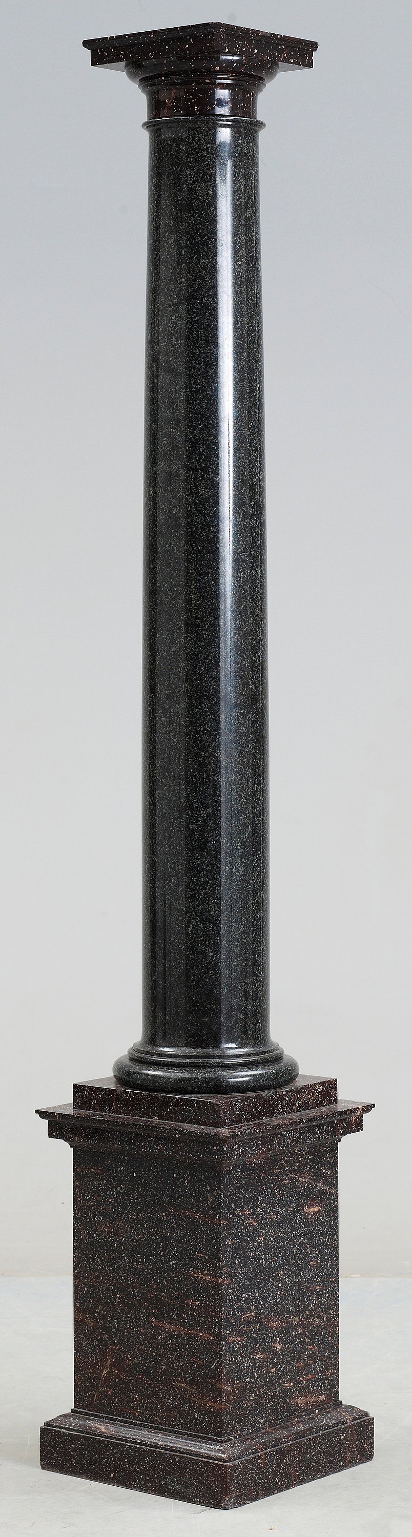 A Swedish 19th century porphyry base and column. - Bukowskis