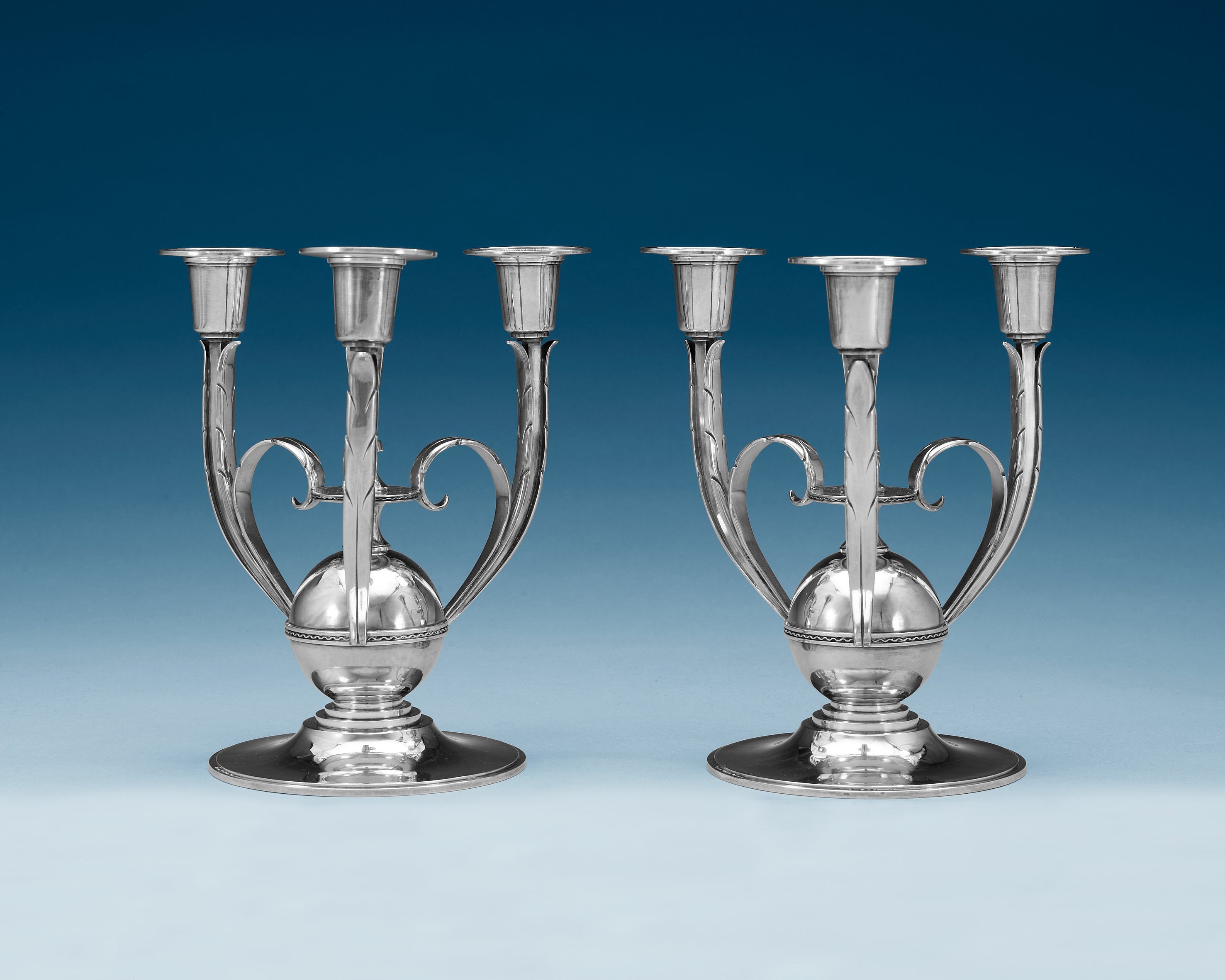 A pair of Atelier Borgila silver candelabra for three candles ...