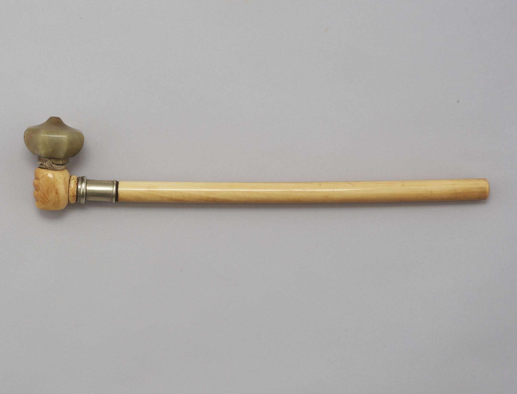 A carved ivory and green stone opium pipe with metal mount, late Qing ...