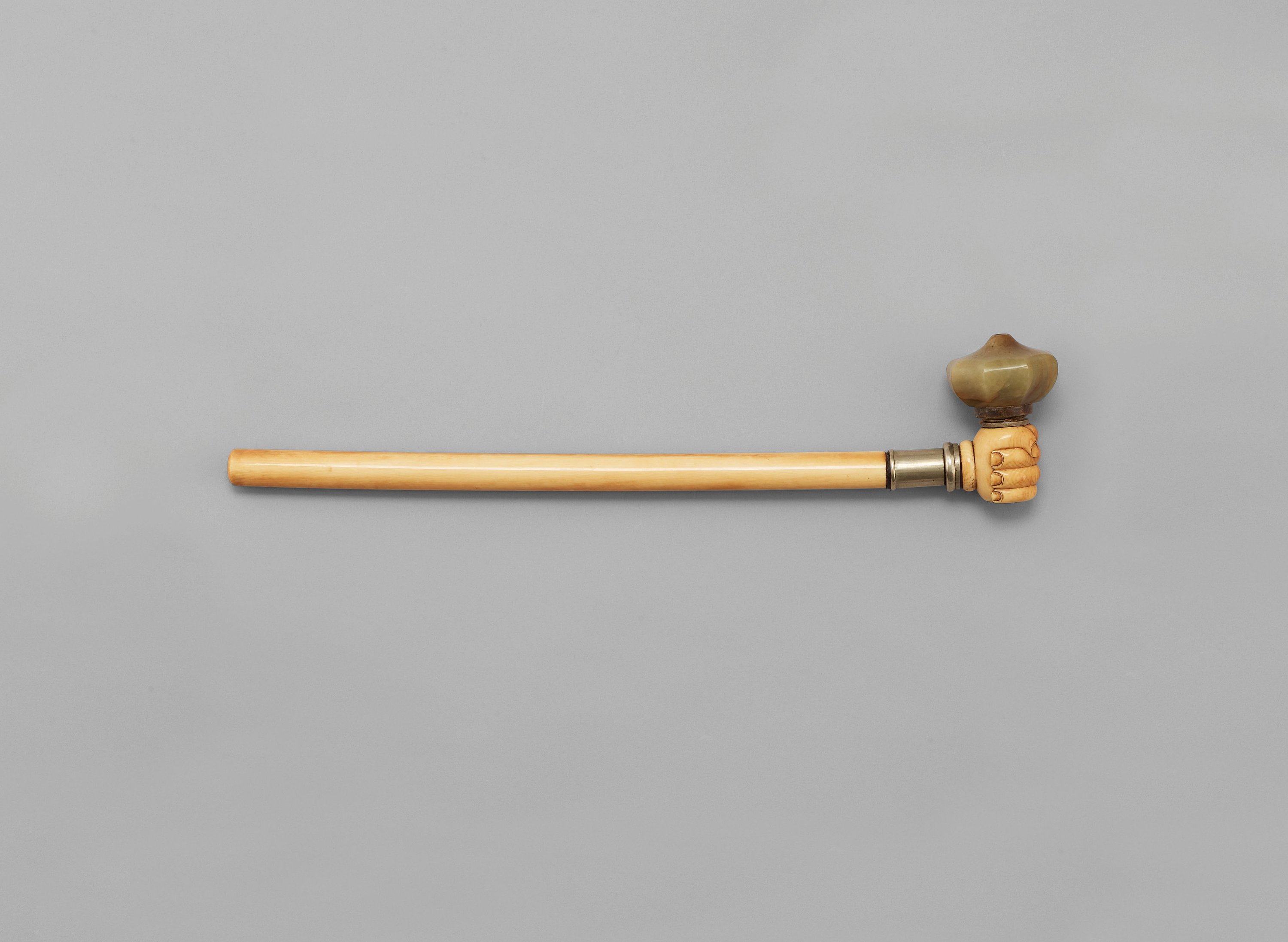 A carved ivory and green stone opium pipe with metal mount, late Qing ...