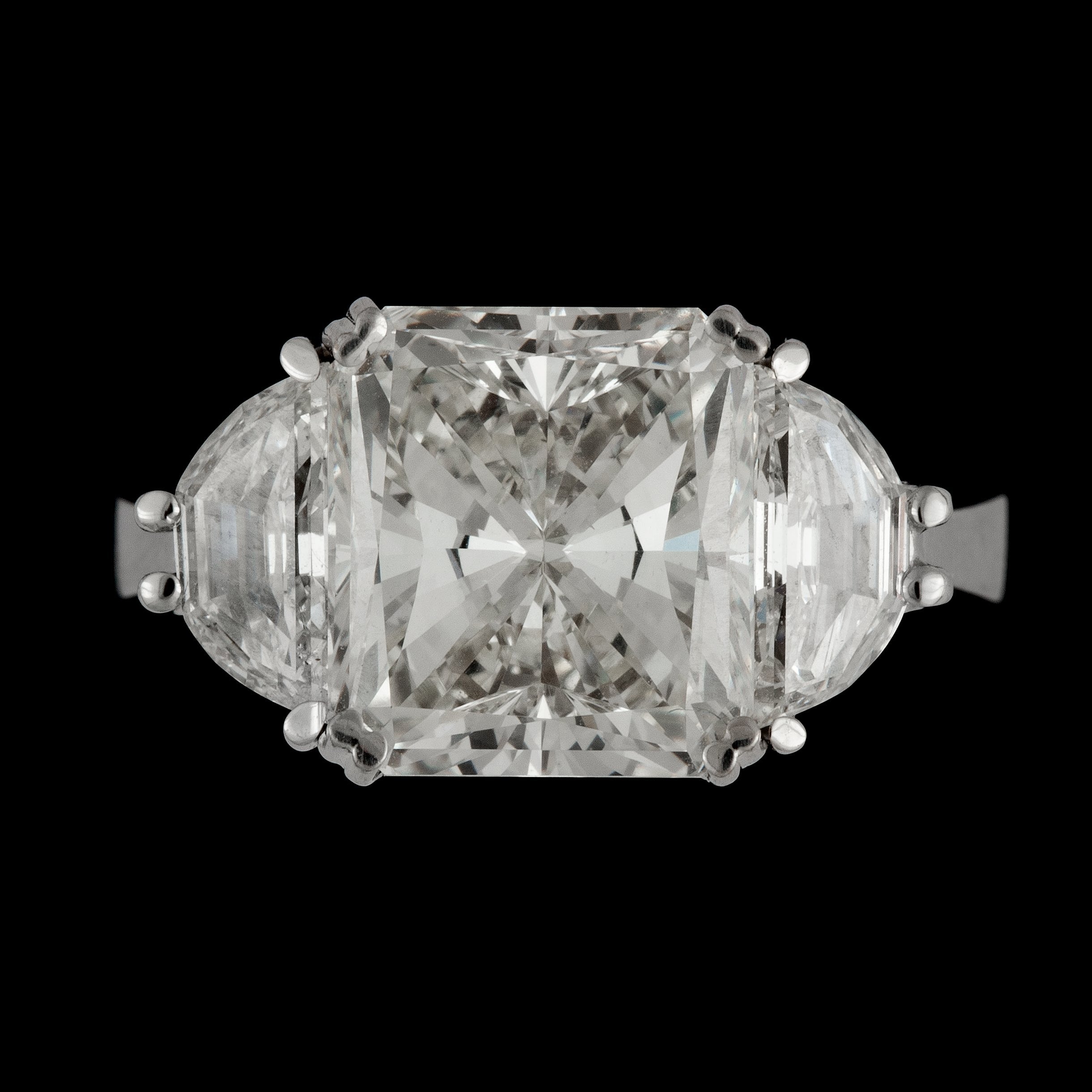 A radiant cut 5.02 cts diamond ring flanked by two half-moon shaped ...