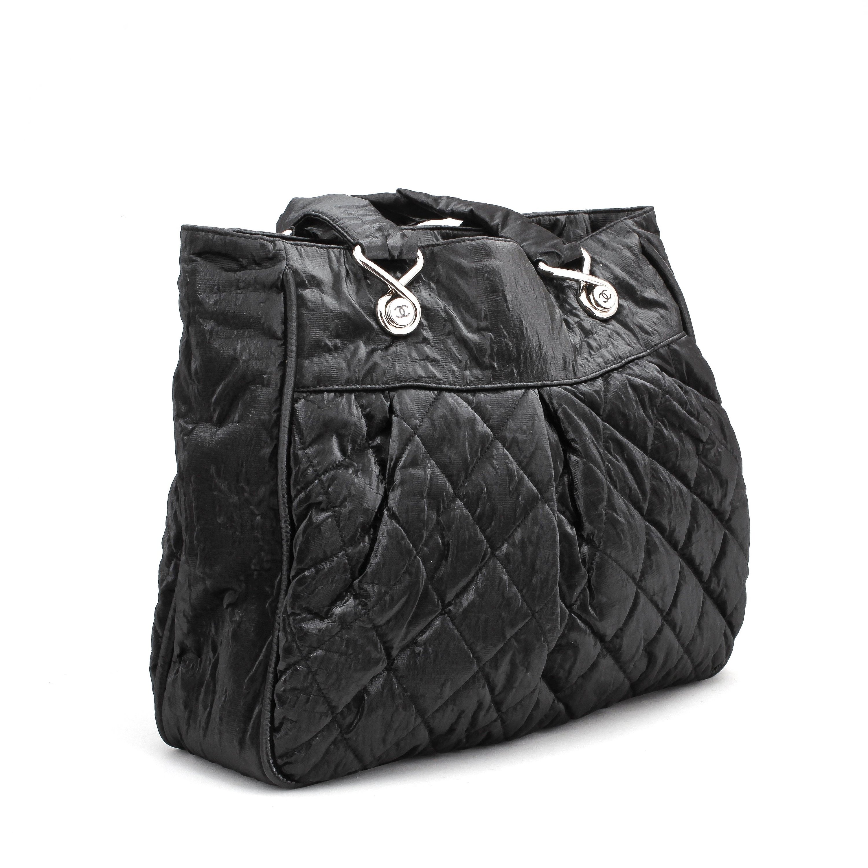 CHANEL a coated black quilted leather bag. - Bukowskis