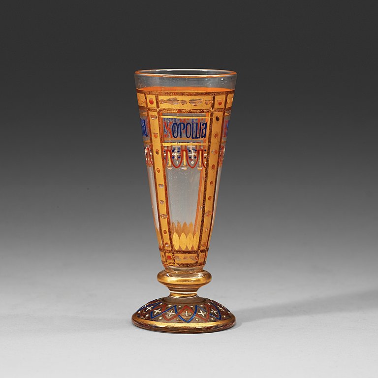 A small Russian vodka glass painted with enamel colours and gold, late ...