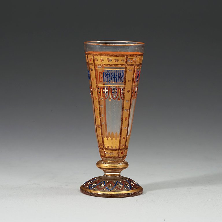 A small Russian vodka glass painted with enamel colours and gold, late ...