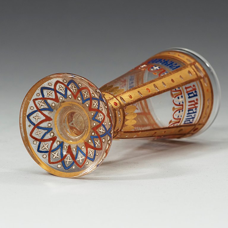 A small Russian vodka glass painted with enamel colours and gold, late ...
