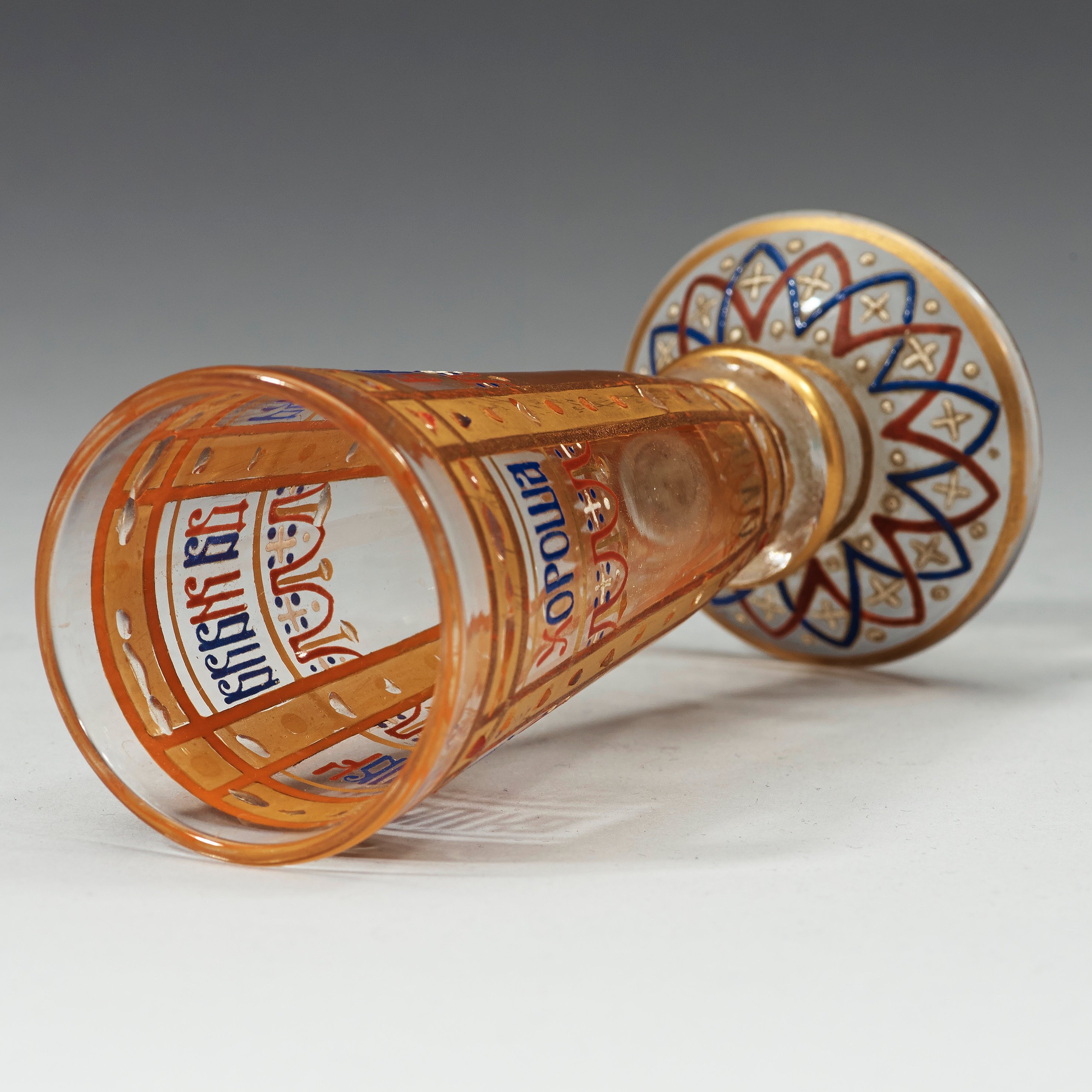 A small Russian vodka glass painted with enamel colours and gold, late ...