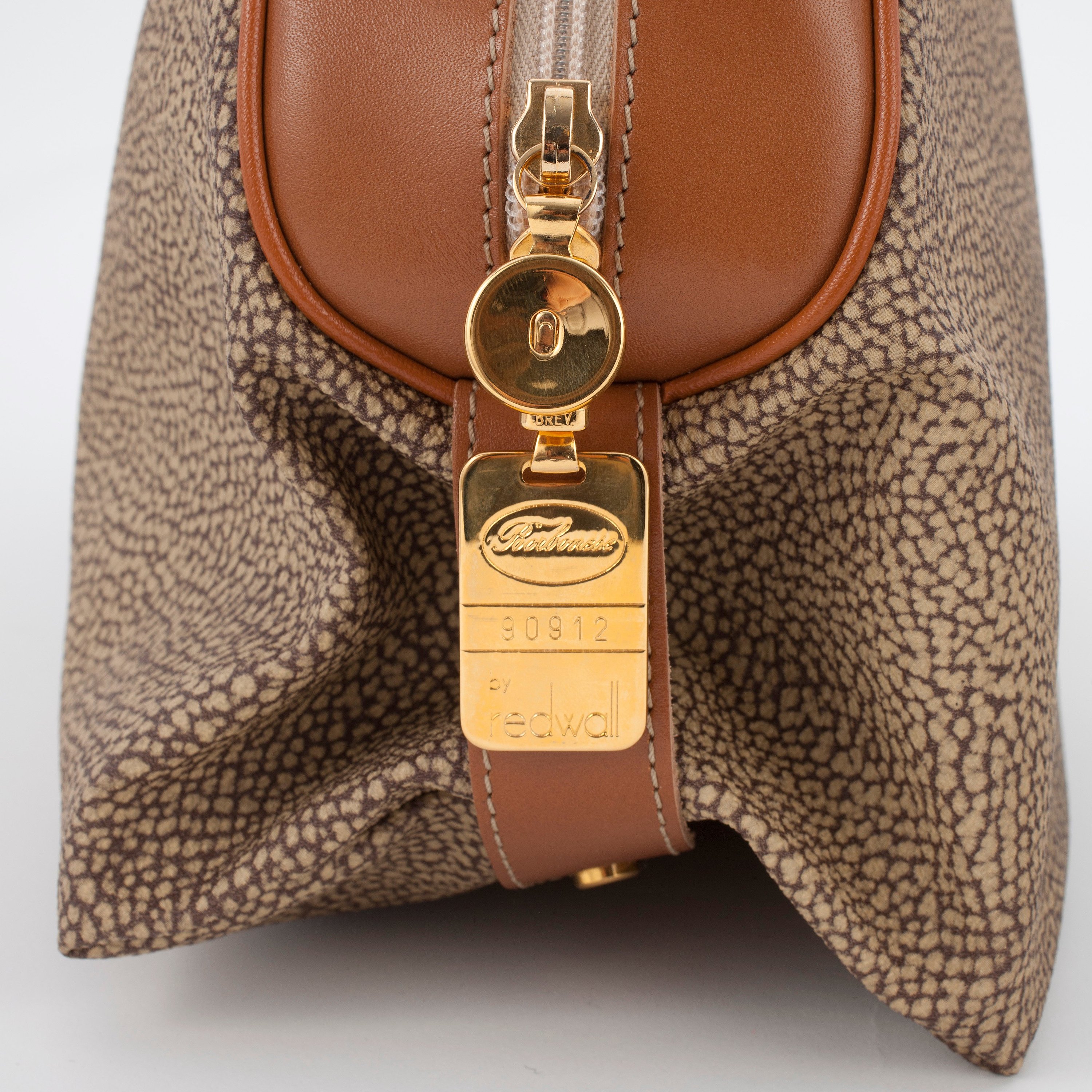 BORBONESE, a brown fabric and leather handbag and toliettrybag from the ...