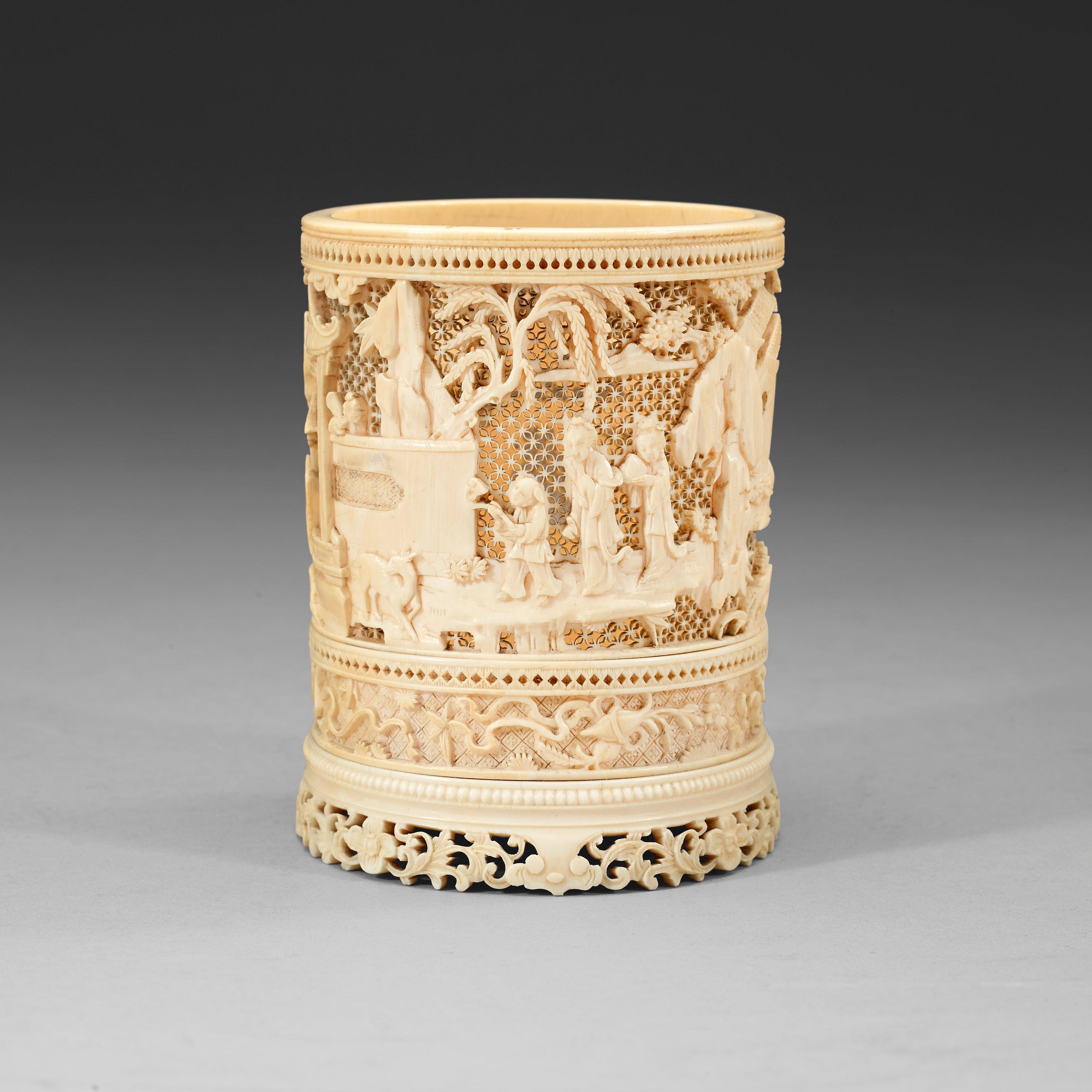 An exquisitely carved and pierced ivory brush pot, Qing dynasty, 19th ...
