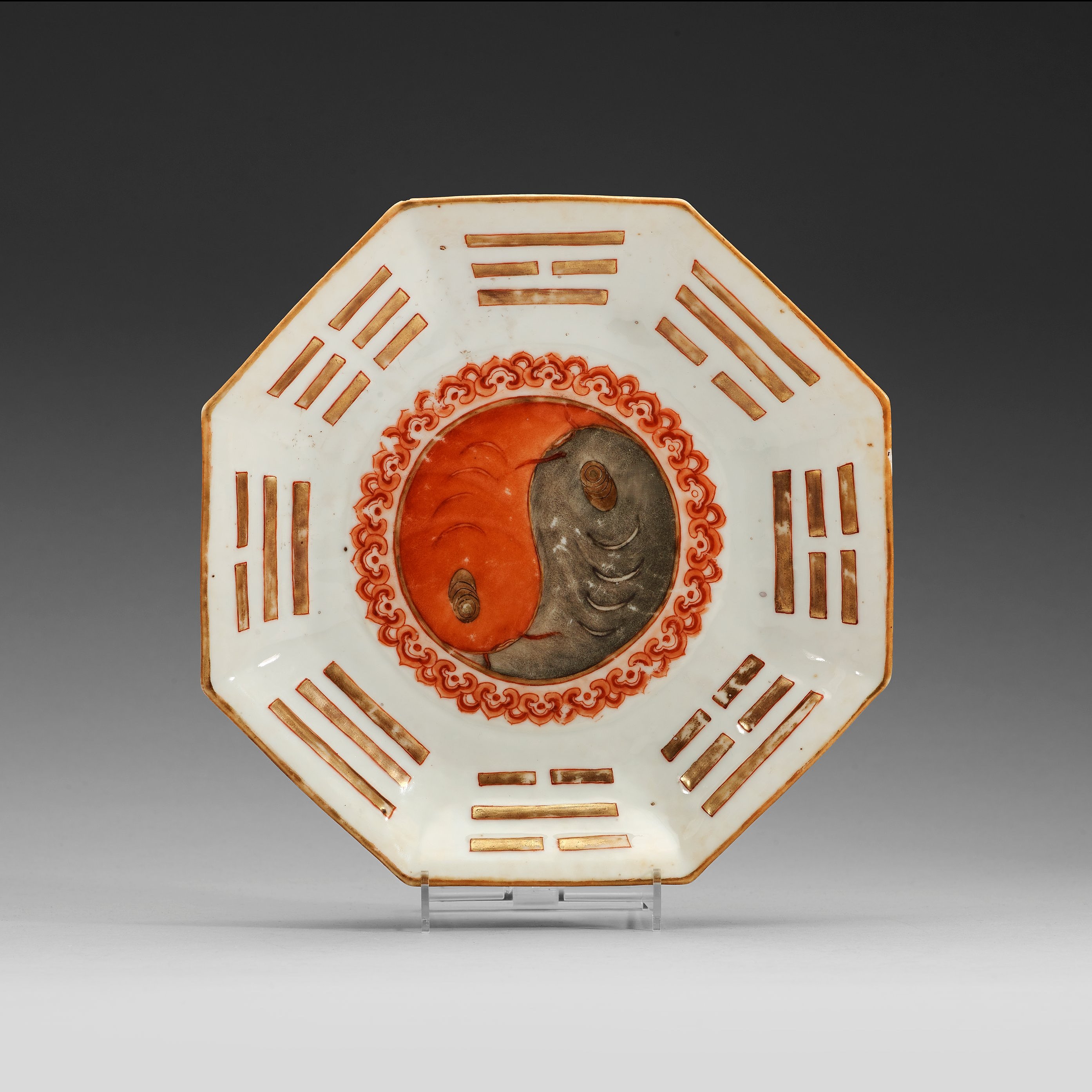 A iron red and gold Ying-Yang octagonal dish, Qing dynasty late 19th ...