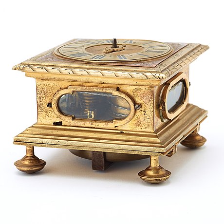 A Baroque 17th century gilt copper table clock. - Bukowskis