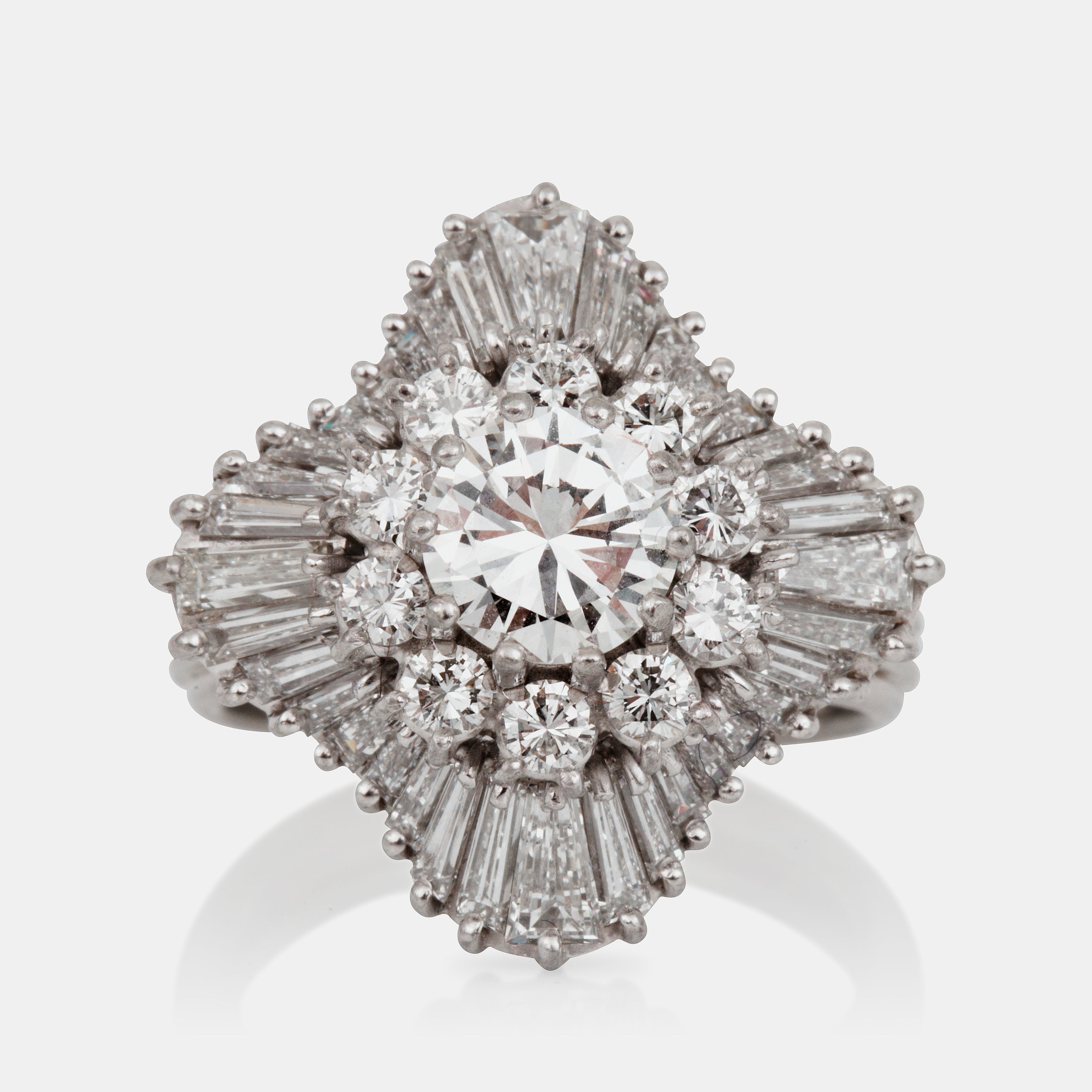 A brilliant- and trapezoid-cut diamond ring. Center diamond circa 1.10 ...