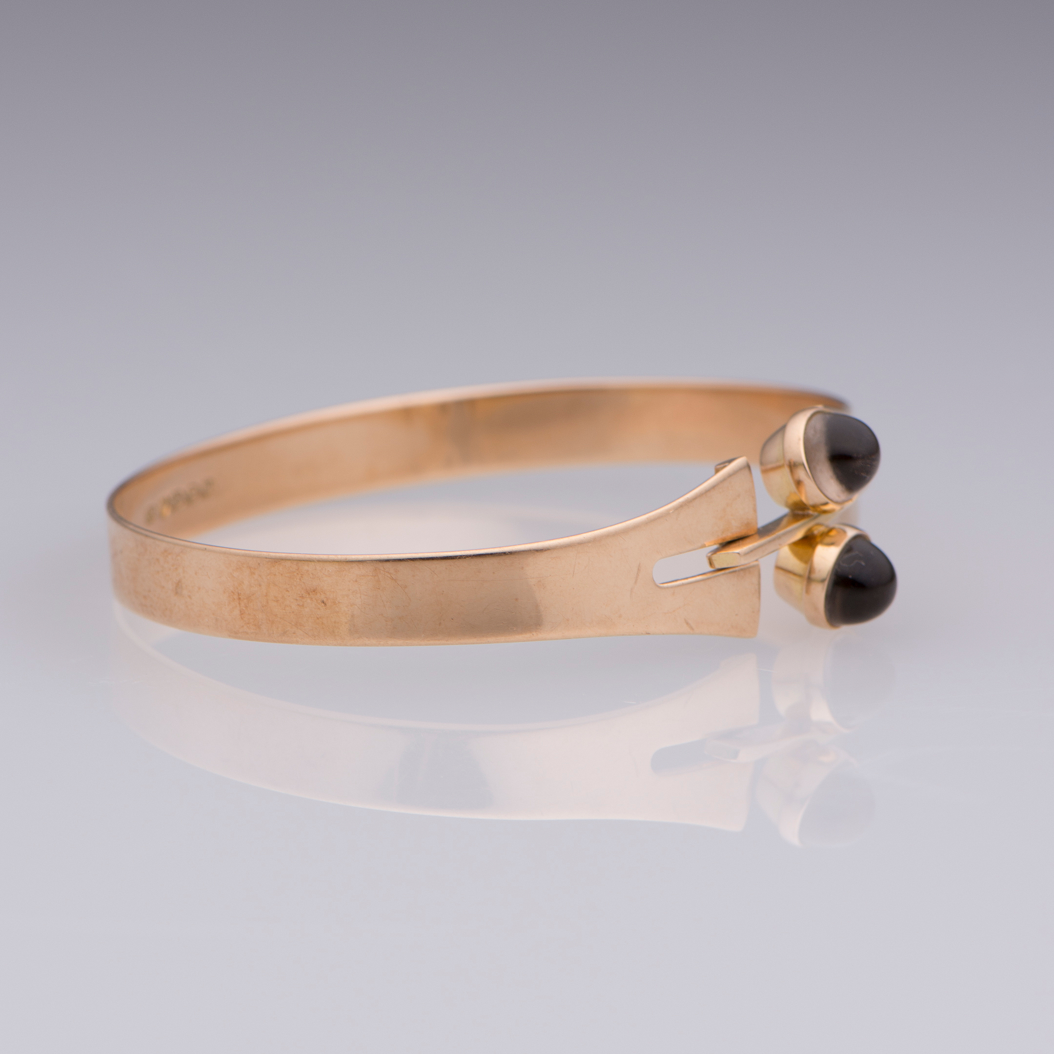 ARMRING, cabochonslipad rökkvarts, 14K guld. Holger Lindström, Helsingfors 1967. - Bukowskis