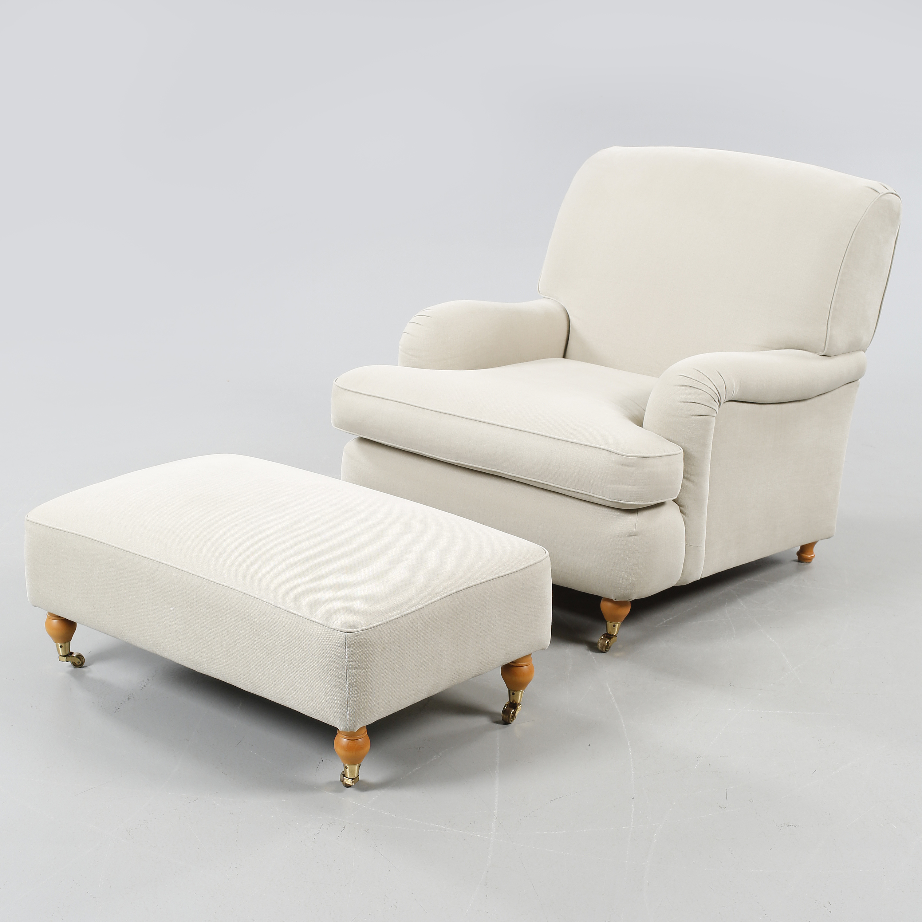 A Howard style lounge chair with footstool, 21th century. - Bukowskis