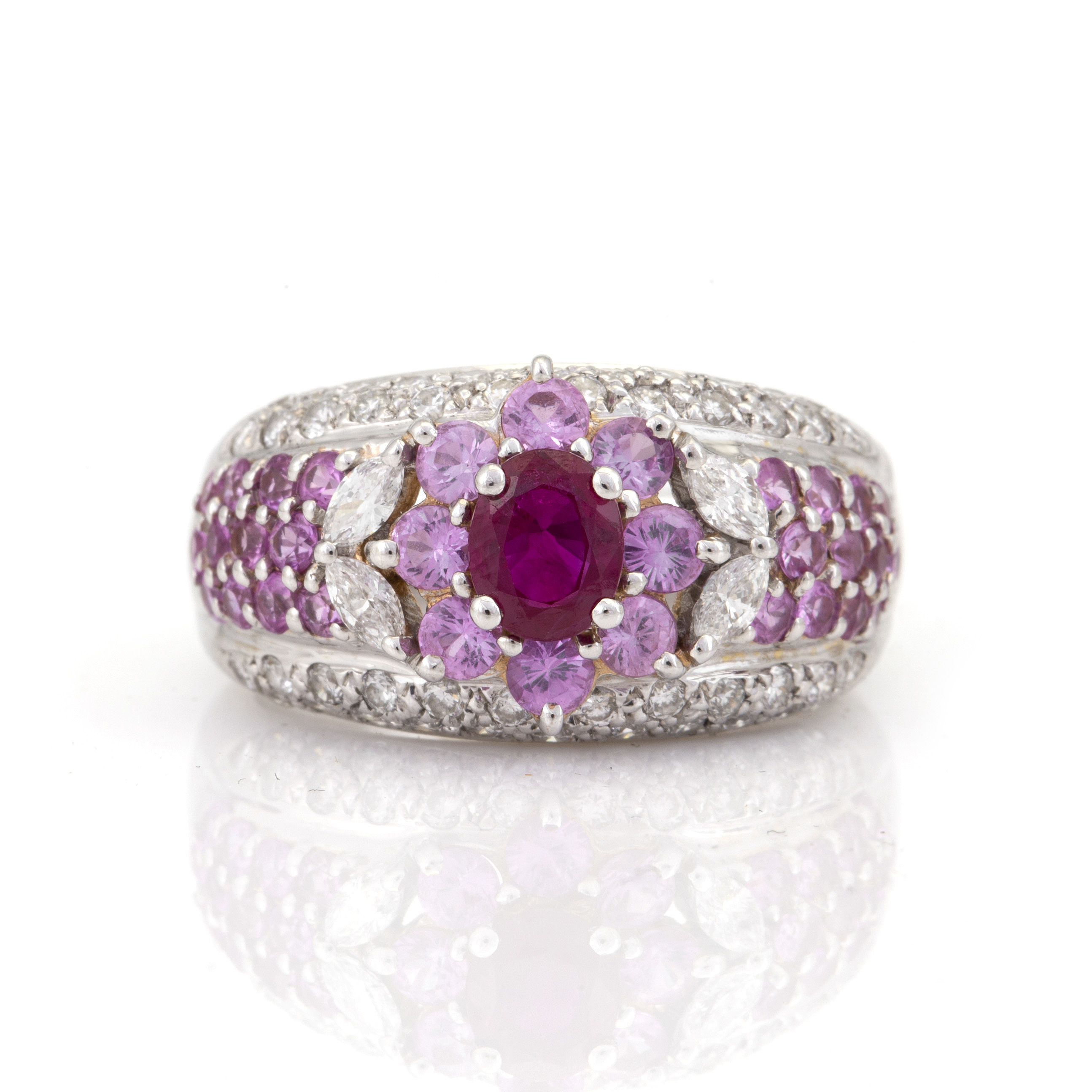 A ring set with an oval, mixed-cut ruby, pink sapphires and diamonds ...