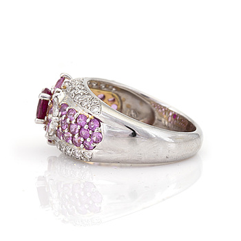 A ring set with an oval, mixed-cut ruby, pink sapphires and diamonds ...