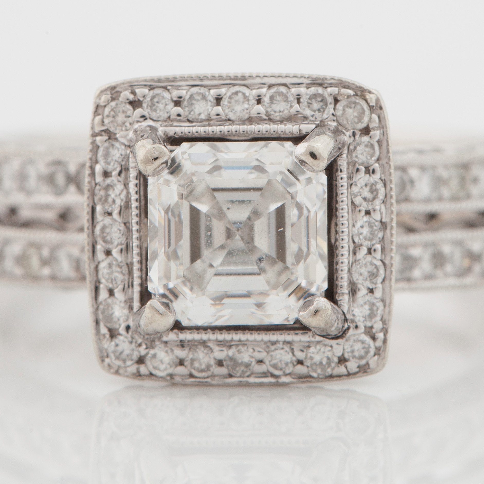 A 1.04 ct Assher cut diamond, quality F/VS1, ring. Shan with pavé set ...