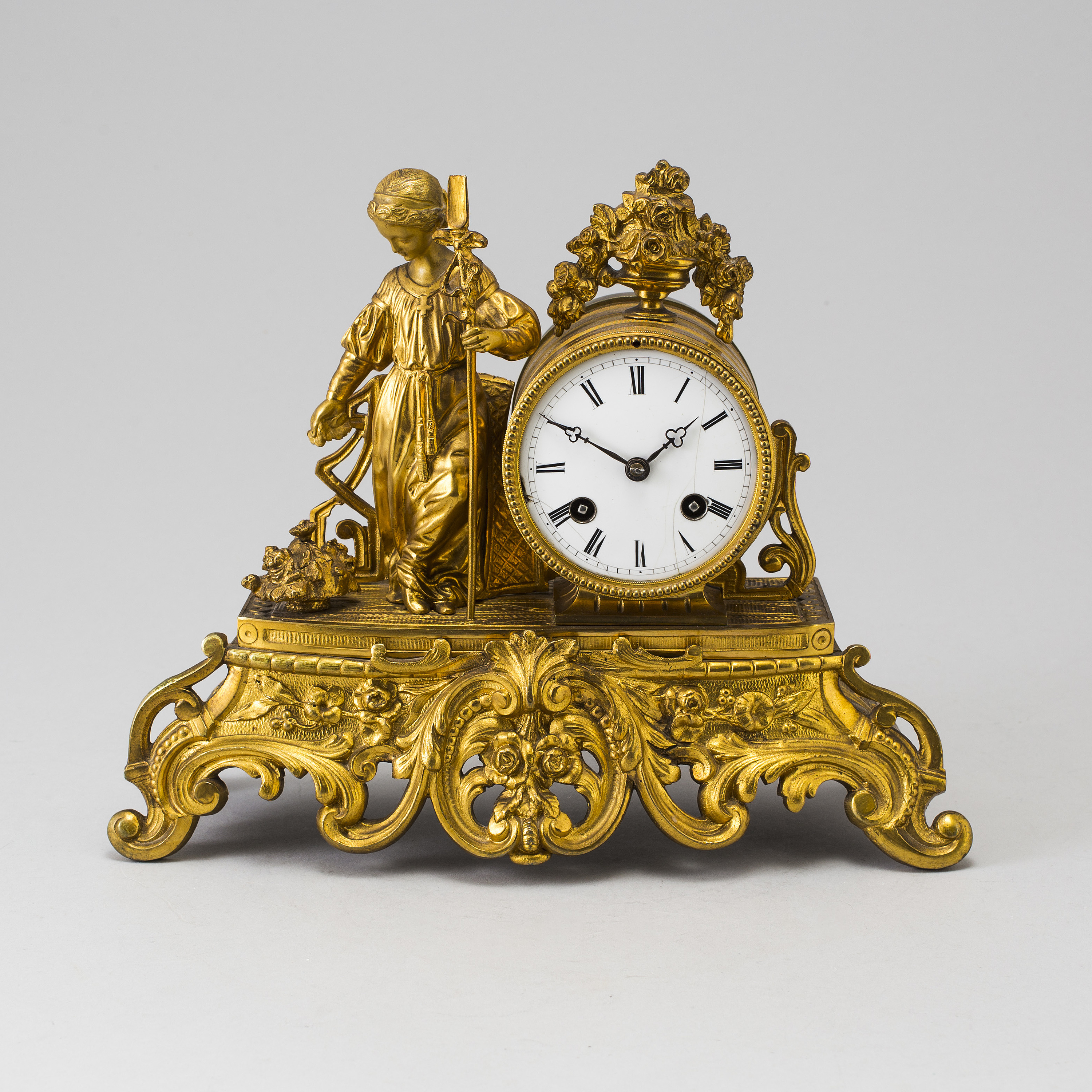 A LATE 19TH CENTURY GILT METAL MANTLE CLOCK in the Rococo style ...