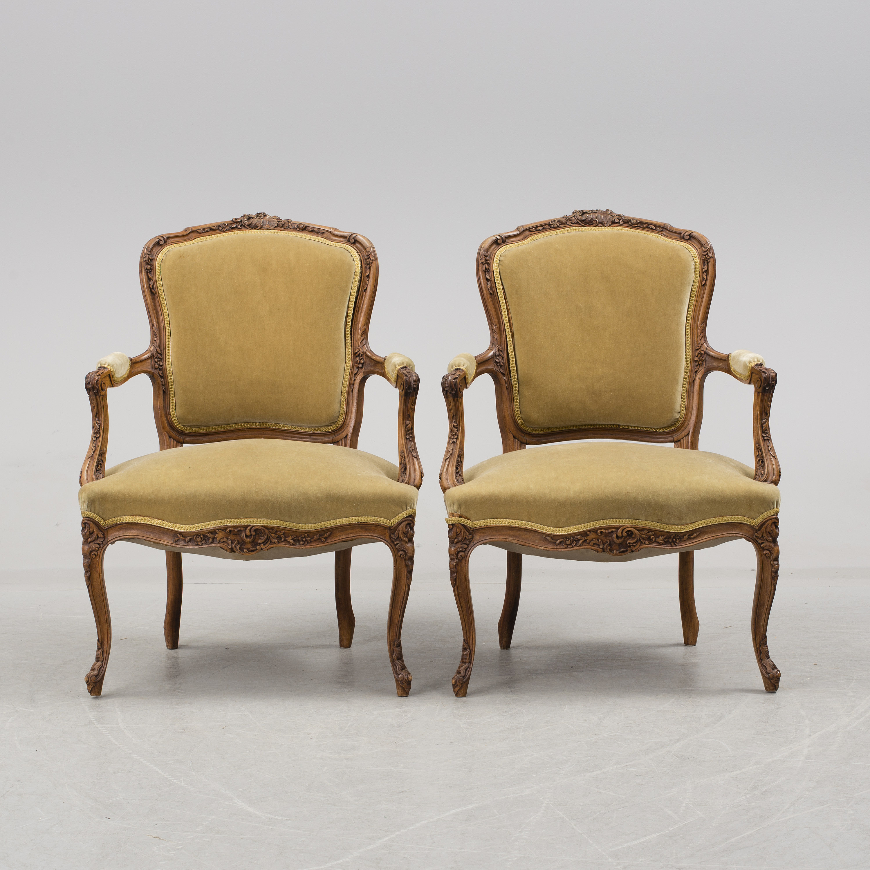a pair of walnut rococo style armchairs from the first half of the 20th ...