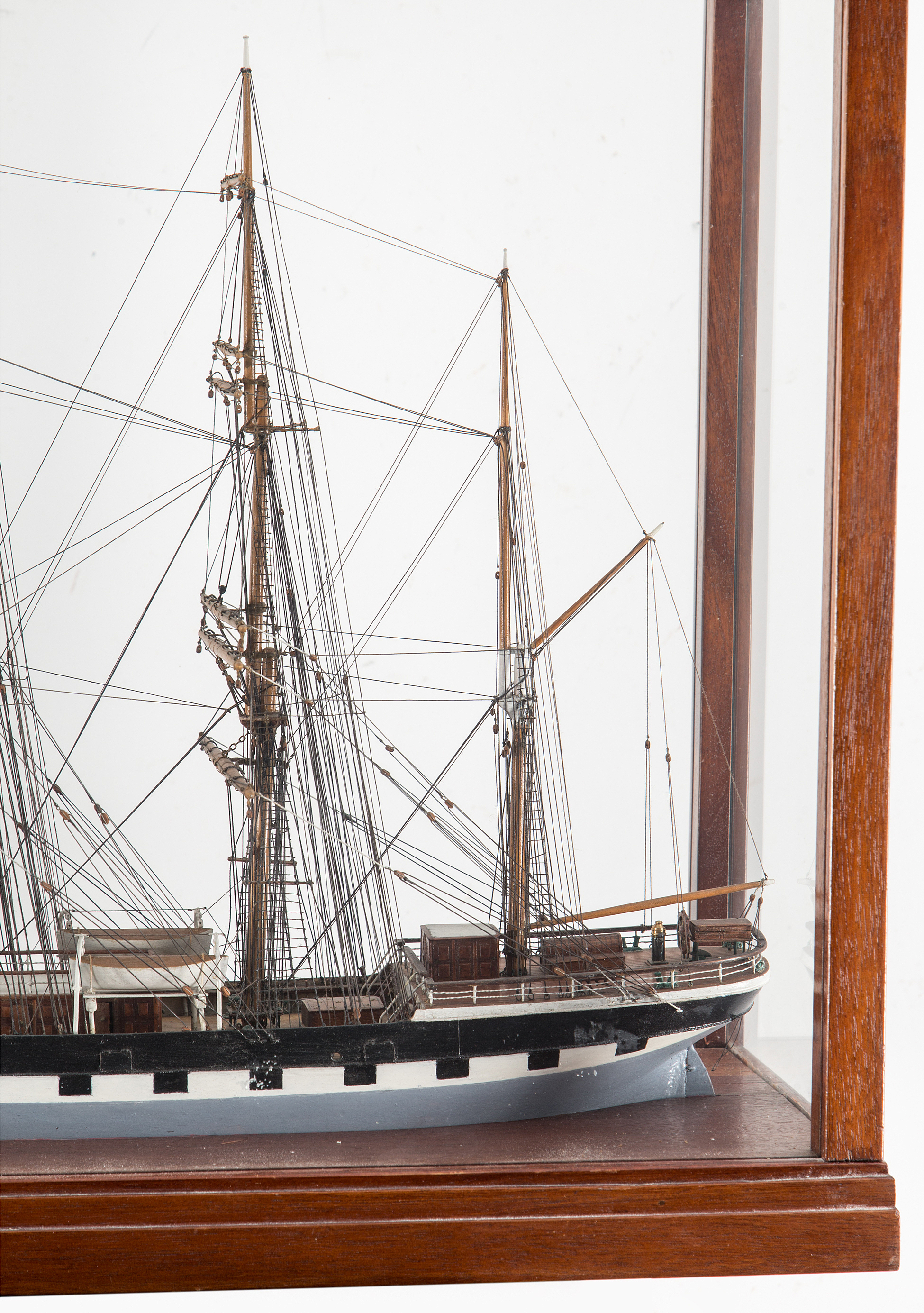 A model of a sailing ship with four masts in a glass and mahogany box ...