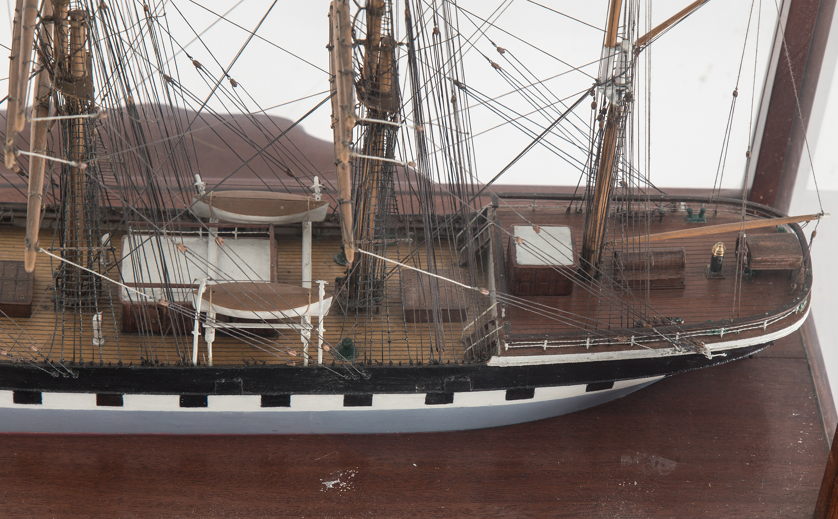 A model of a sailing ship with four masts in a glass and mahogany box ...