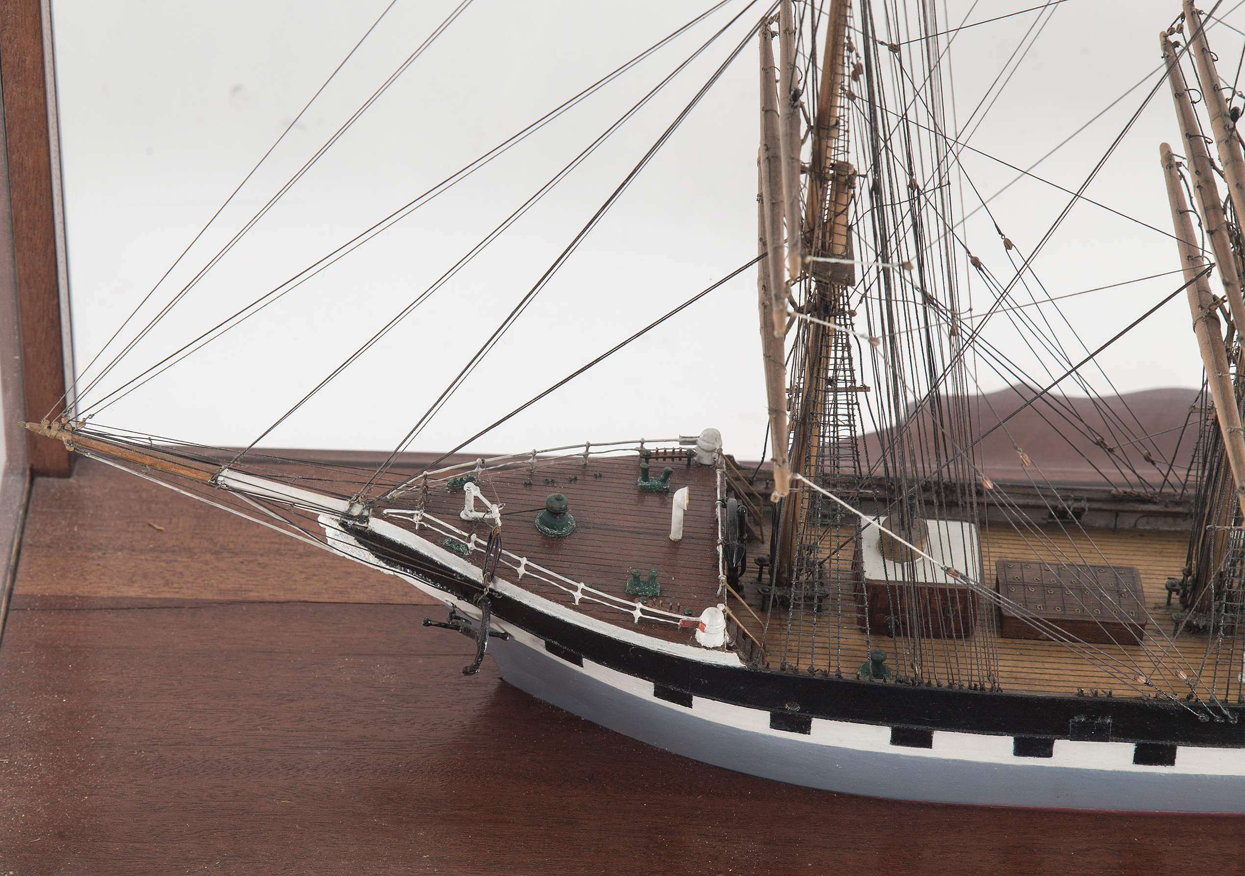 A model of a sailing ship with four masts in a glass and mahogany box ...