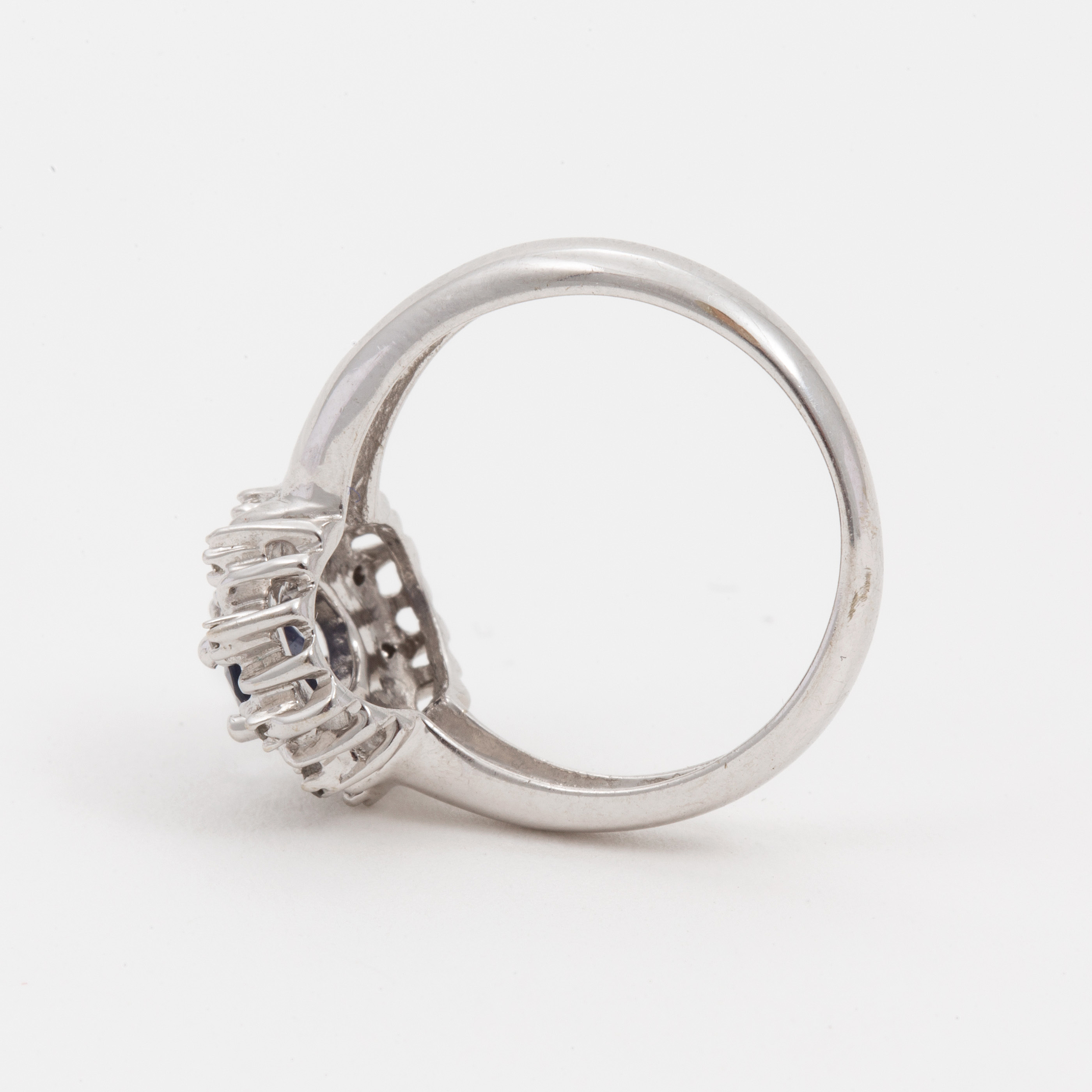A ring set with an oval, mixed-cut, probably synthetic sapphire ...