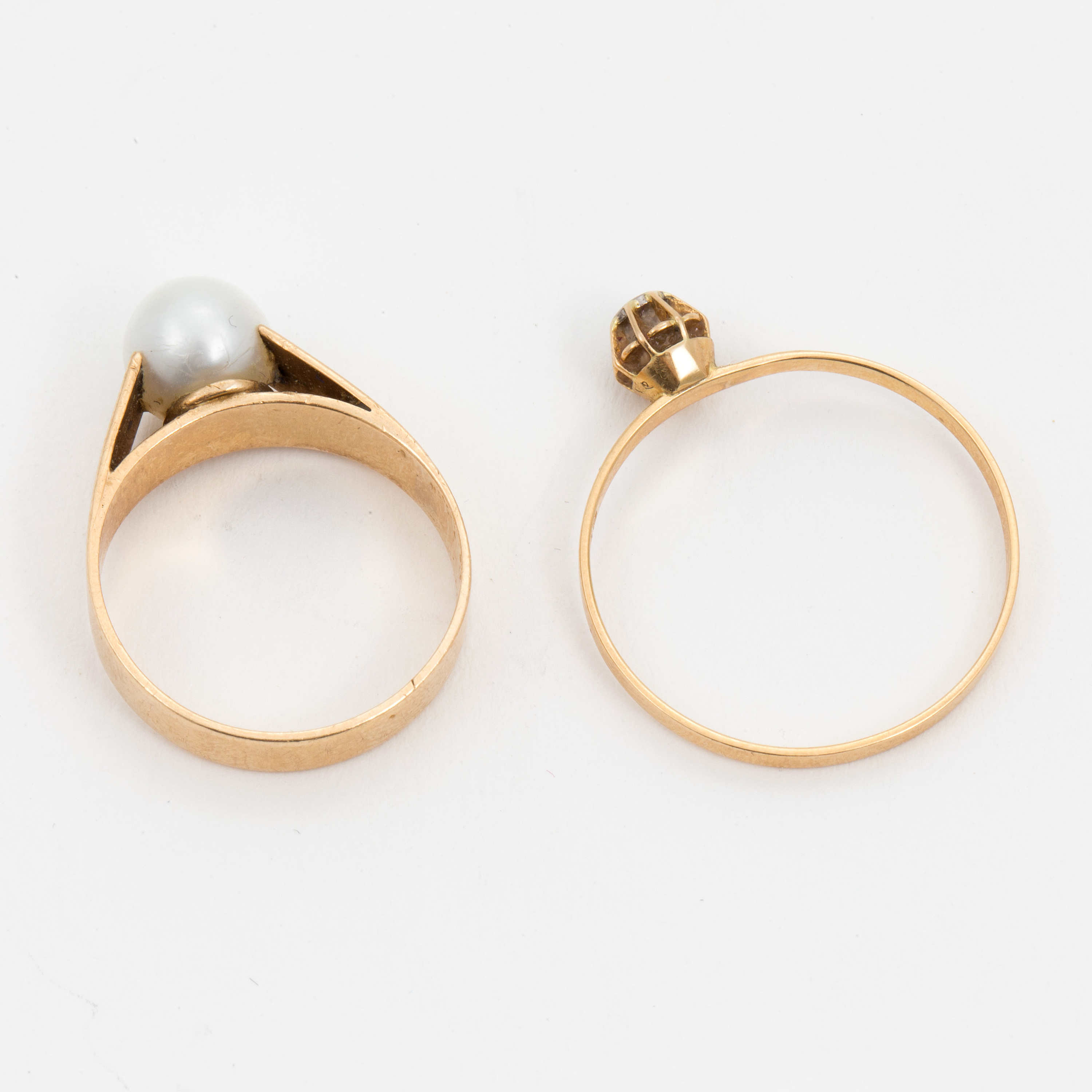Two 18K gold rings, one set with a cultured pearl and one with a ...