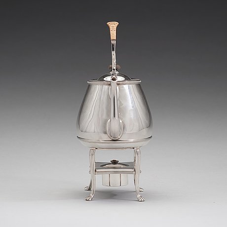 An English 18th century silver tea-pot and stand, mark of Andrew ...